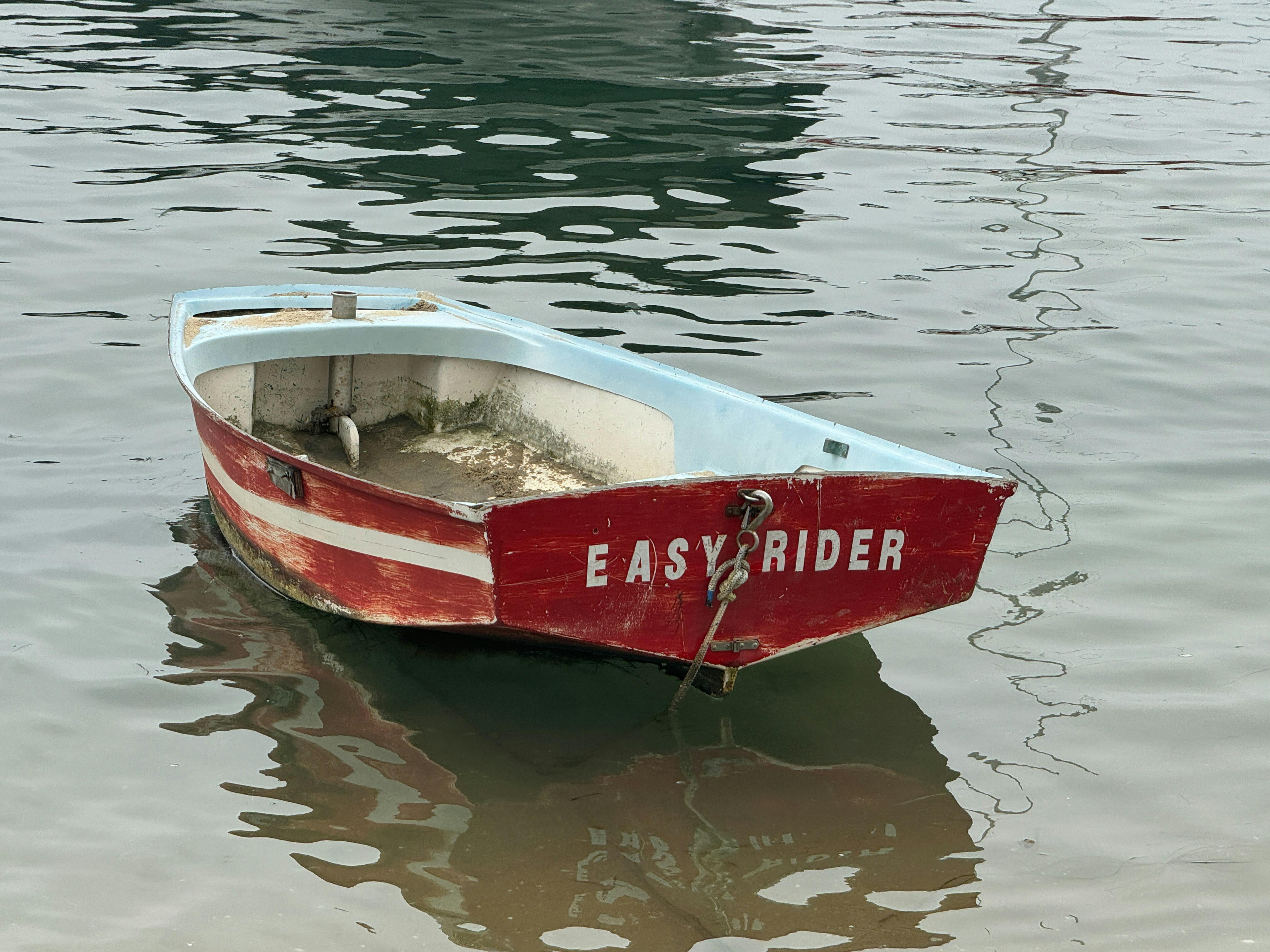 Red Easy Rider Adrift: A Painted Boat on Quiet Waters