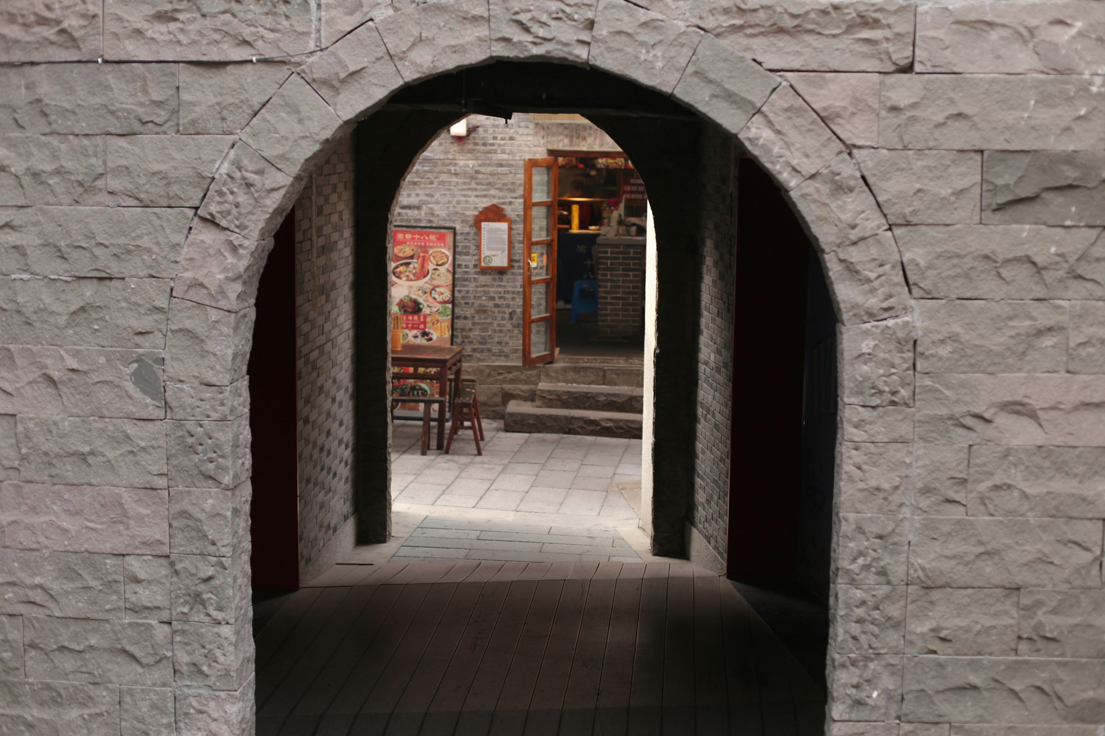 Through the Stone Arch to the Quiet Café