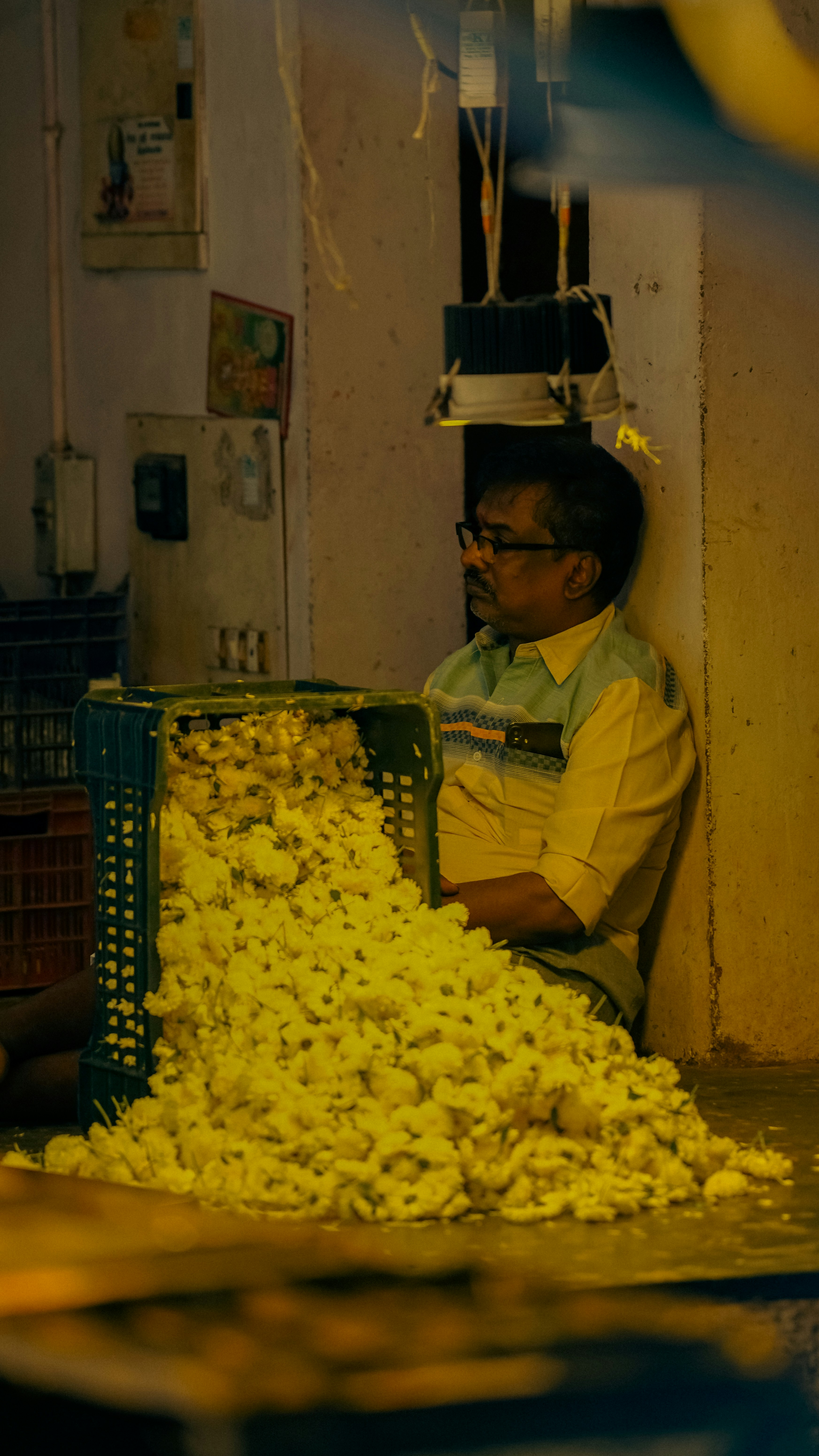 Sleeper among the Blossoms: a vendor's quiet moment in a flower-laden rhythm