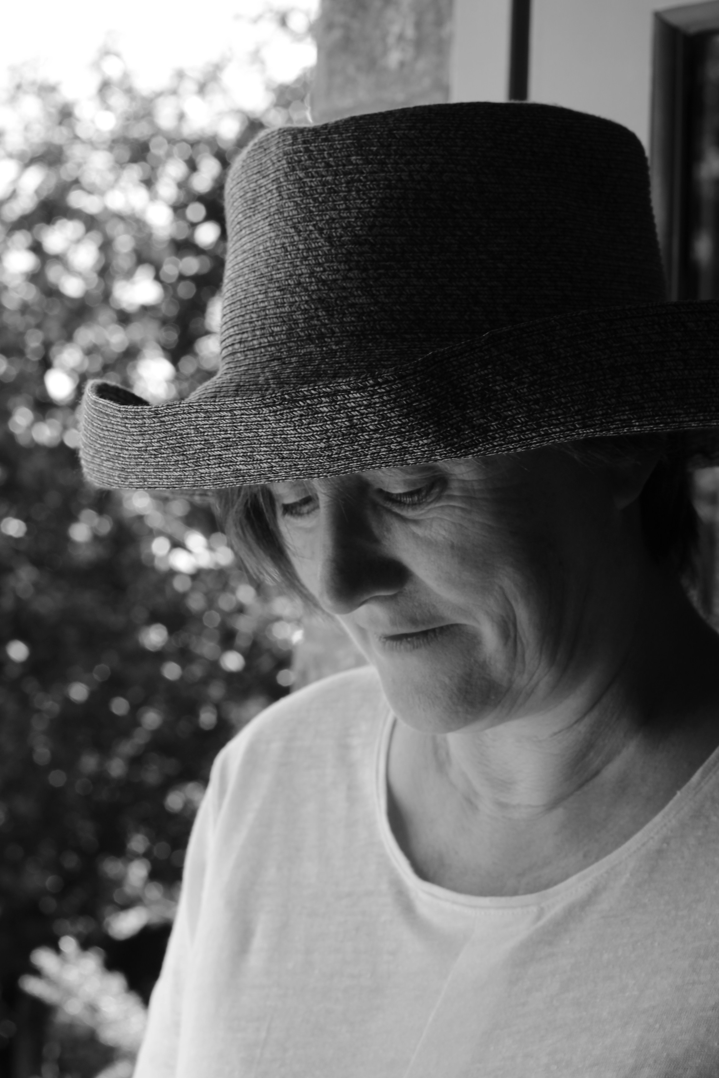 Shadowed Smile Under a Wide Brim