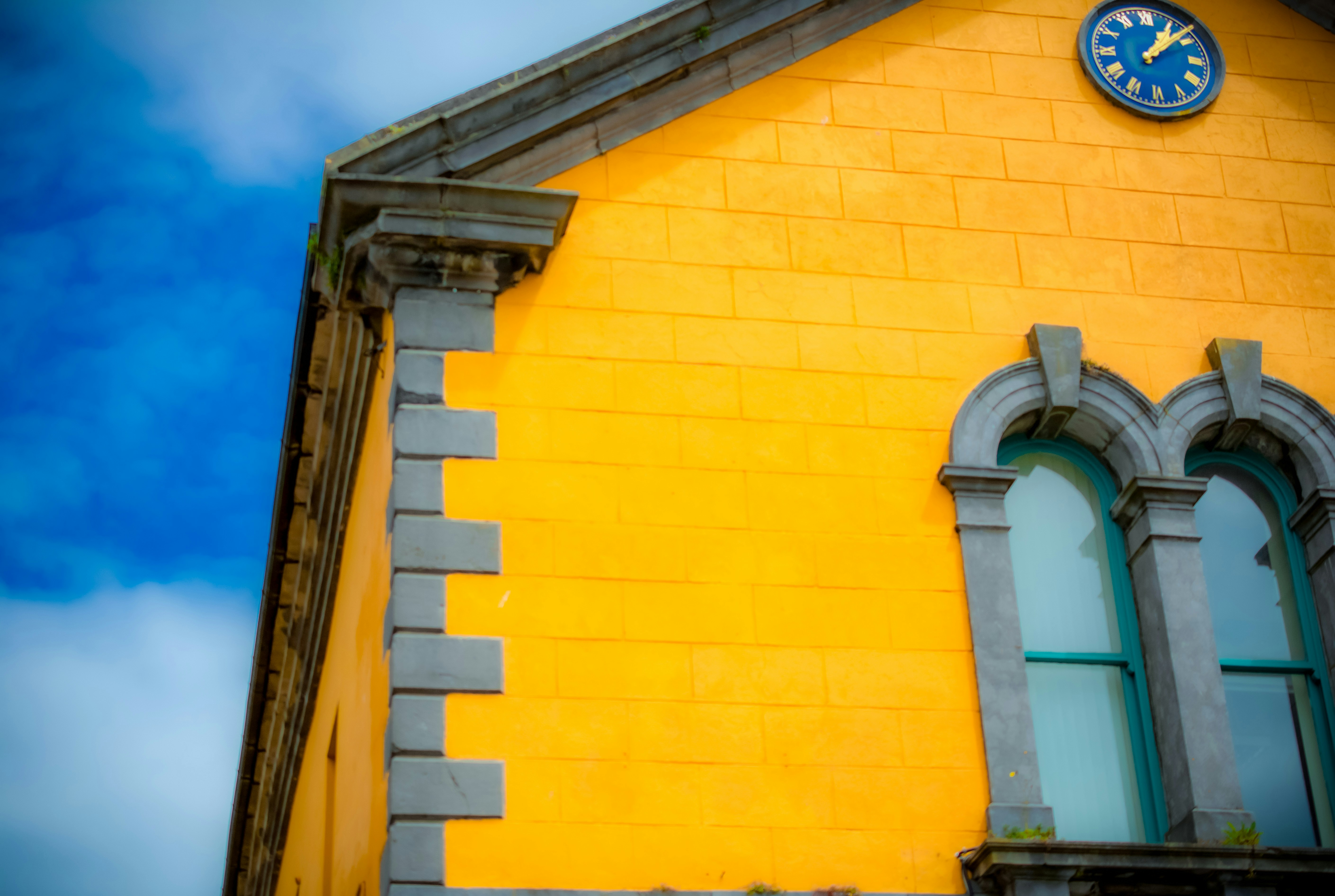 Sunlit Yellow Facade with Clock Tower Edge