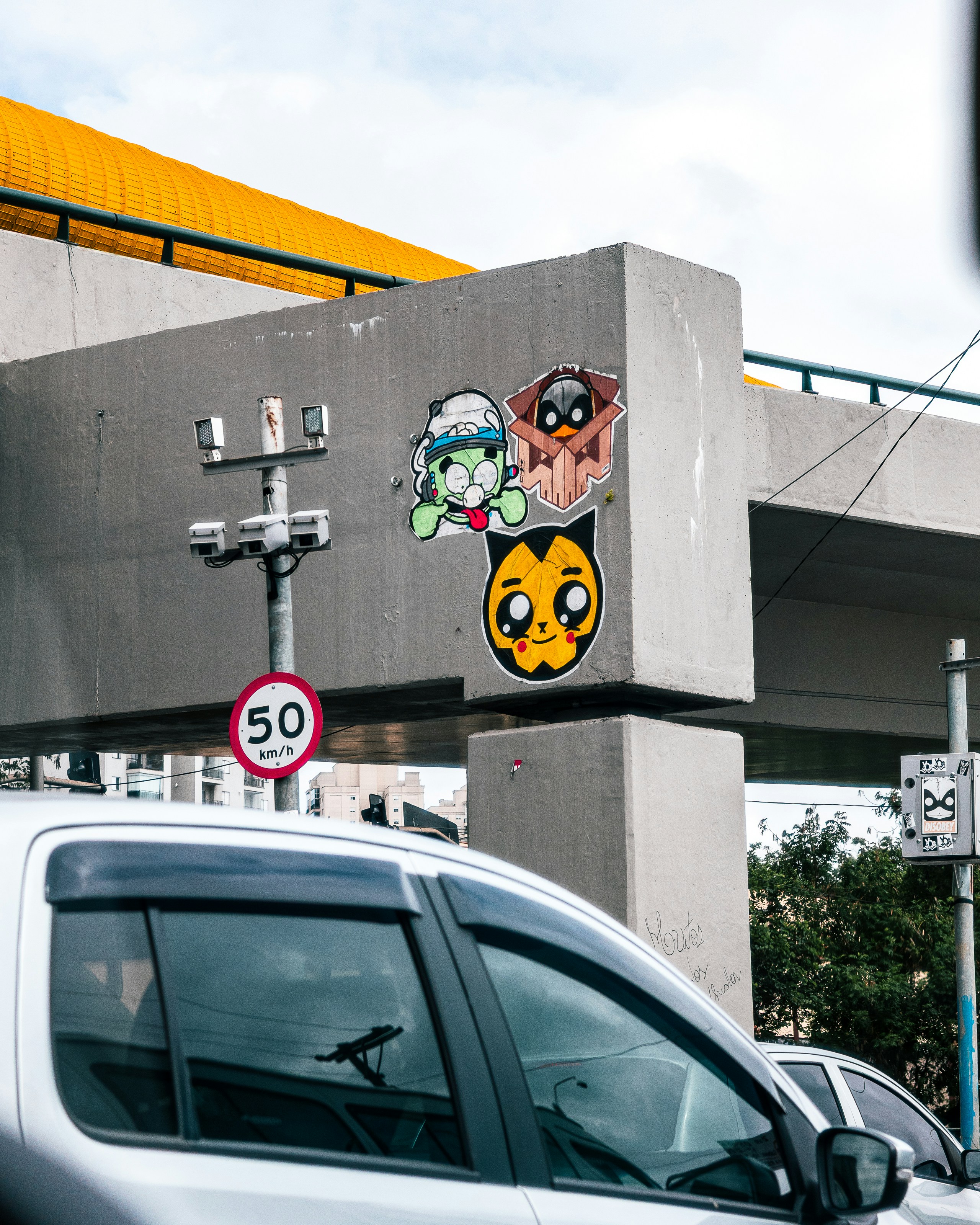Concrete Overpass Mural: Street Icons Guard the 50 km/h Zone
