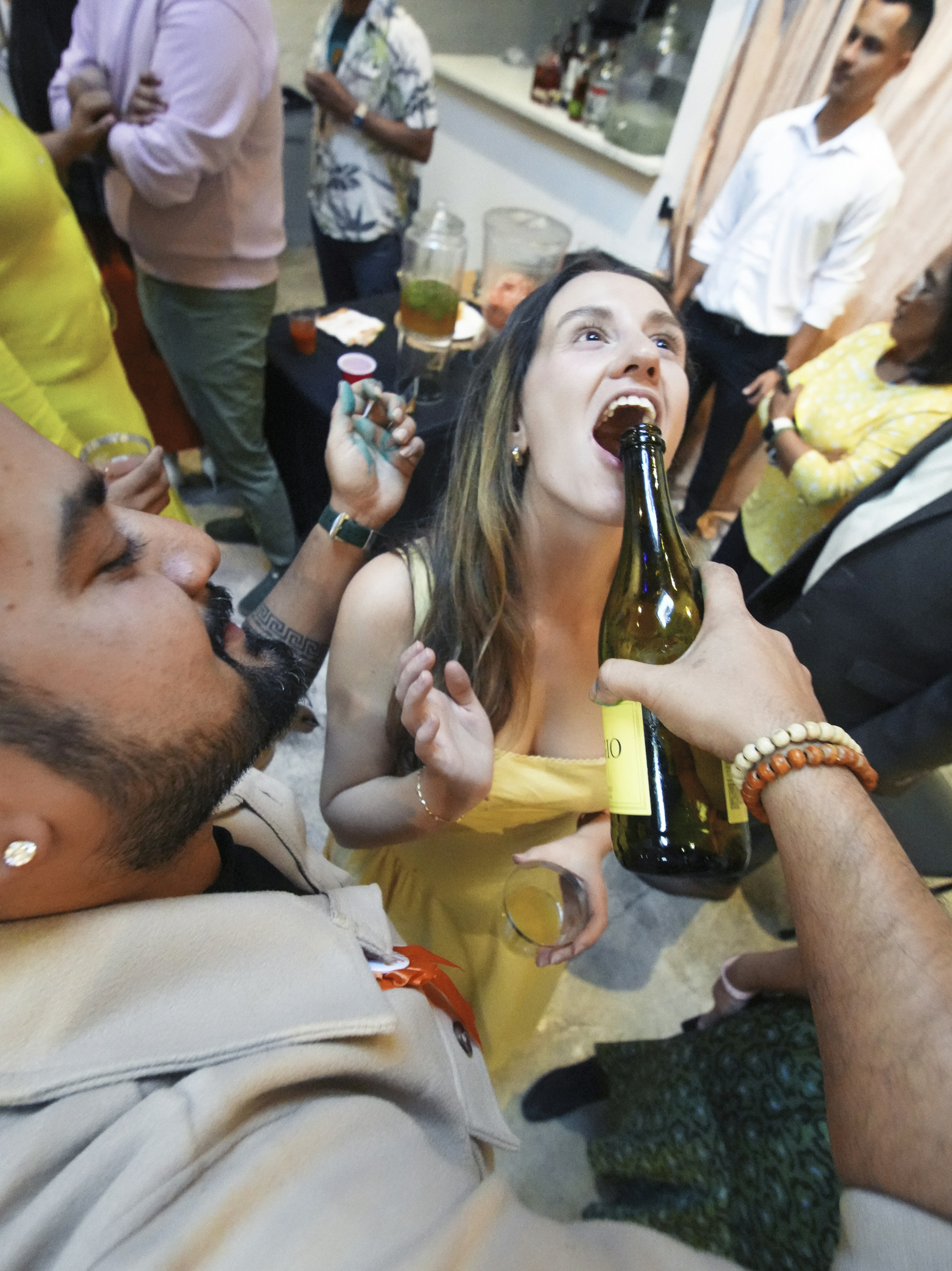 Toast in the Spotlight: A Bottle Party Surges Amid a Lively Crowd