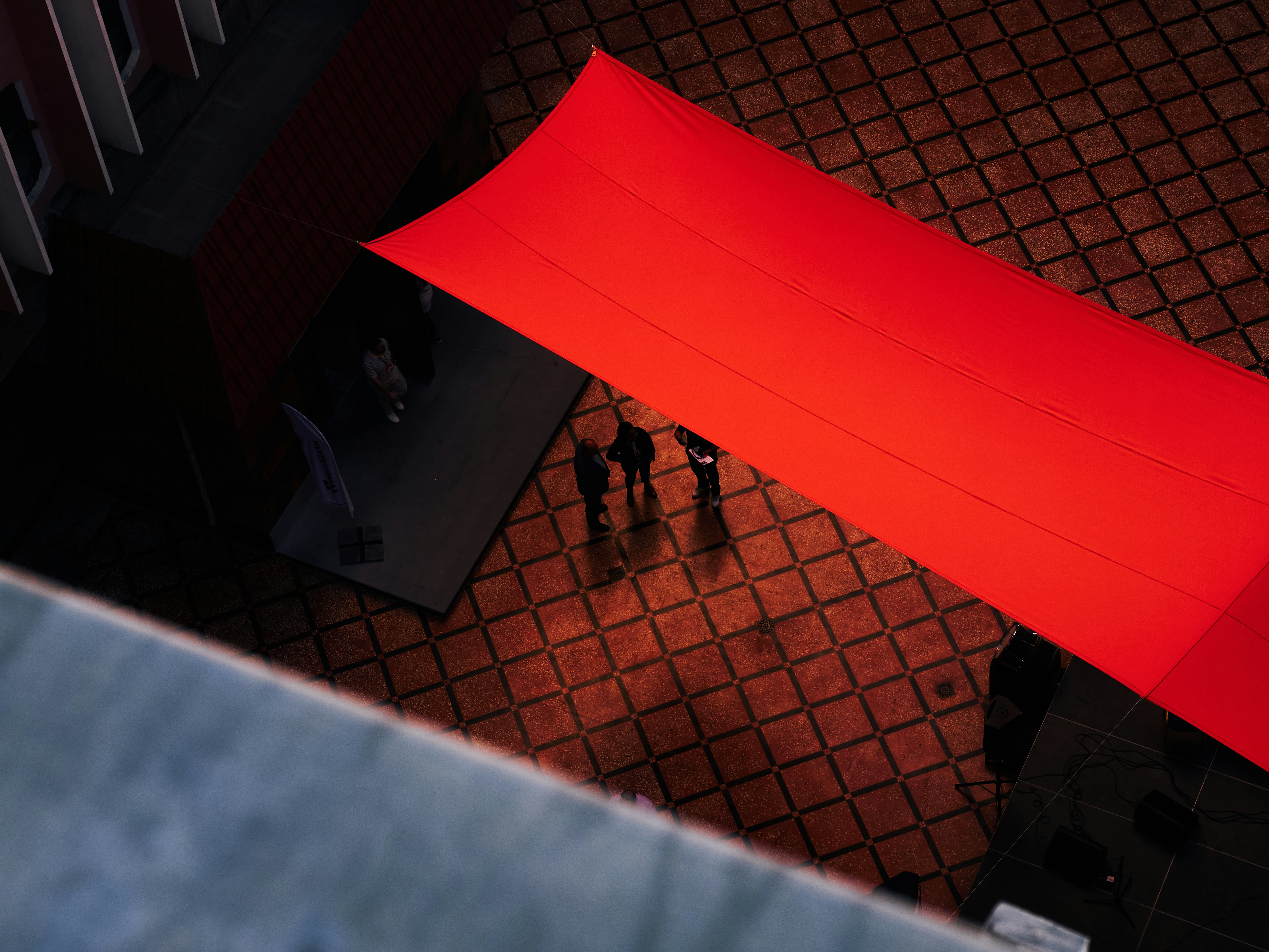 Red Canopy Over a Quiet Courtyard
