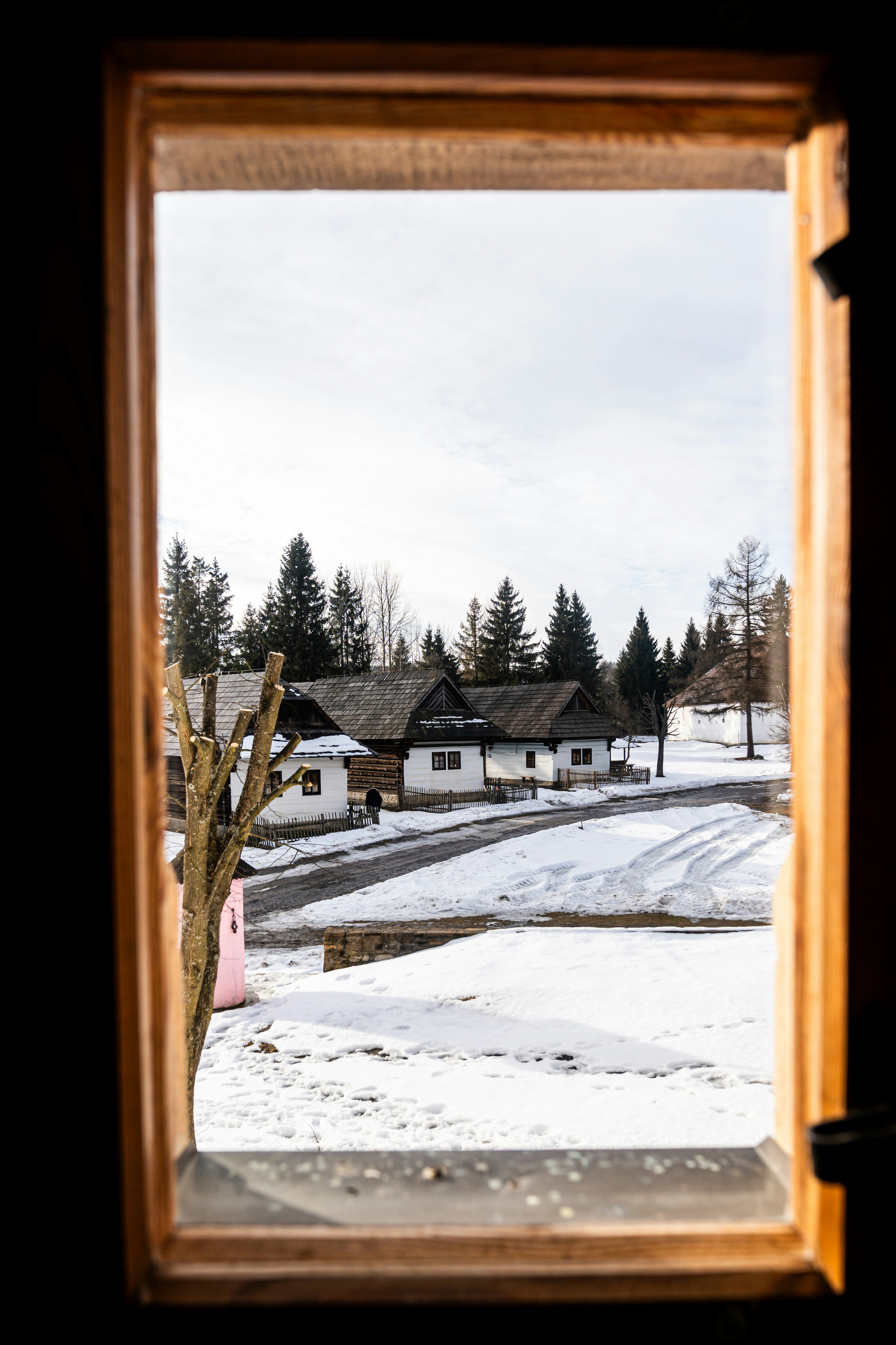 Snowbound Village Window: A Framing of Quiet Winter Light