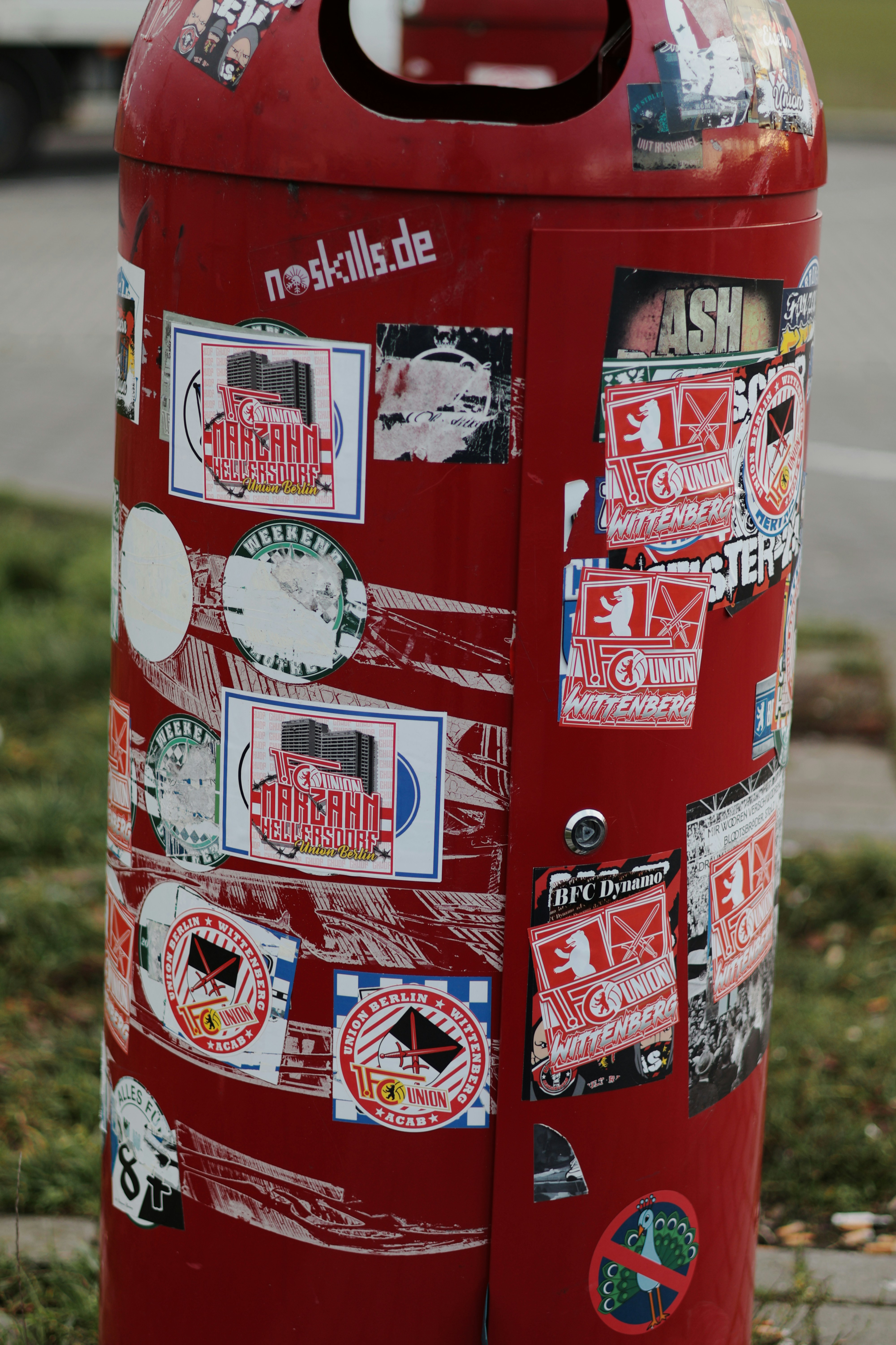 Stickered Red Canister: A Portrait of Urban Debris