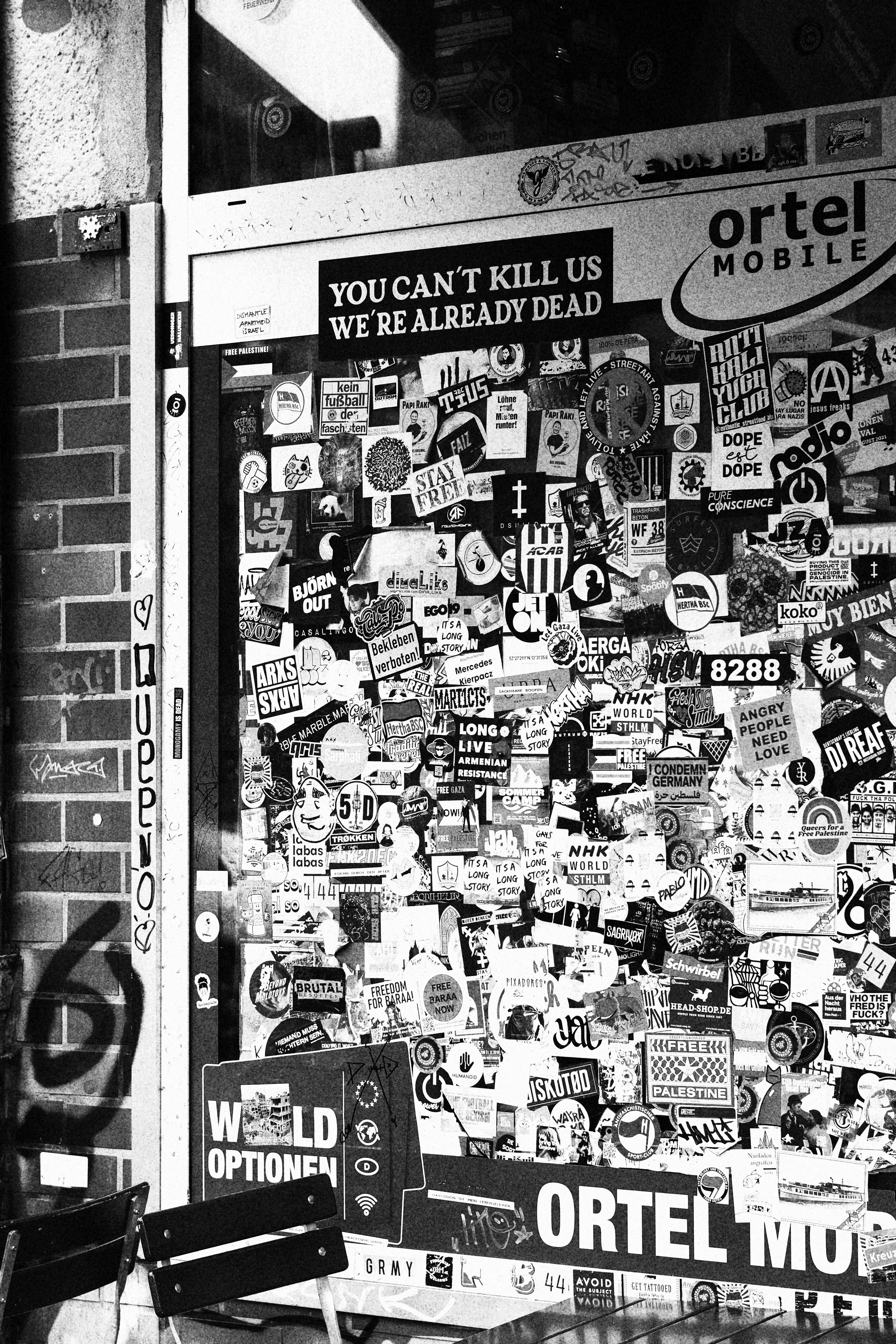 Sticker Wall Overdrive: A Collage of Street Graffiti and Decals