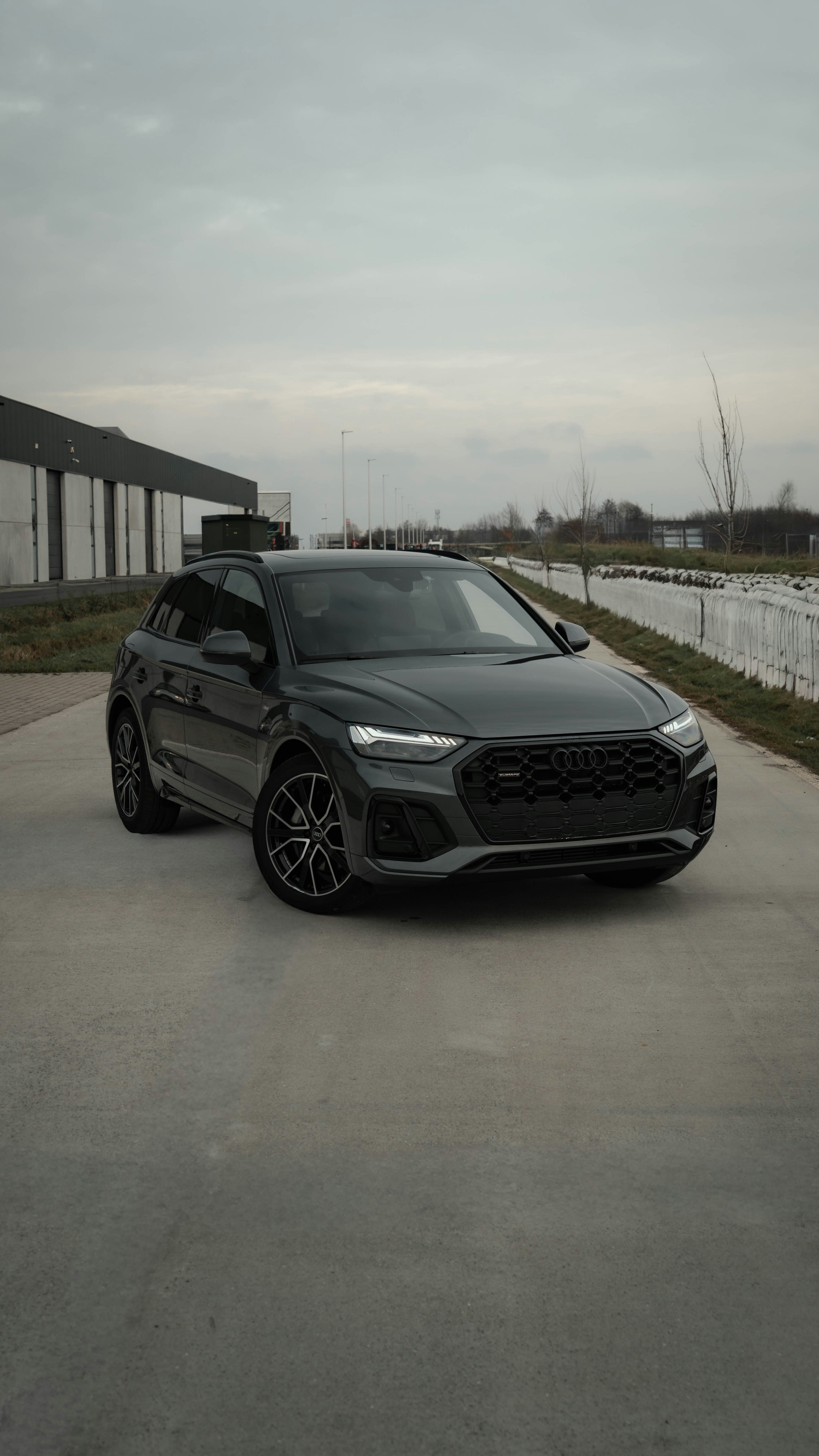 Midnight Drive: A Dark Audi SUV Anchors a Quiet Industrial Road