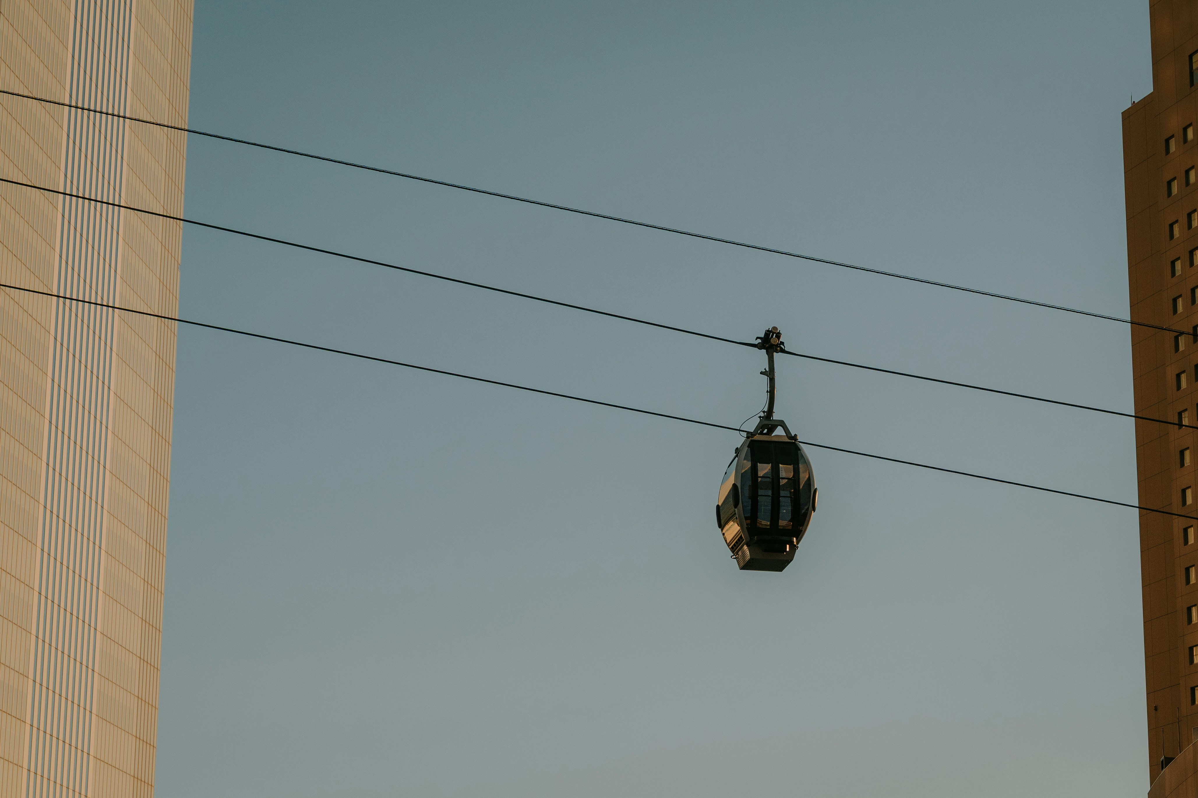 Mid‑Air Cable Car Against Sky