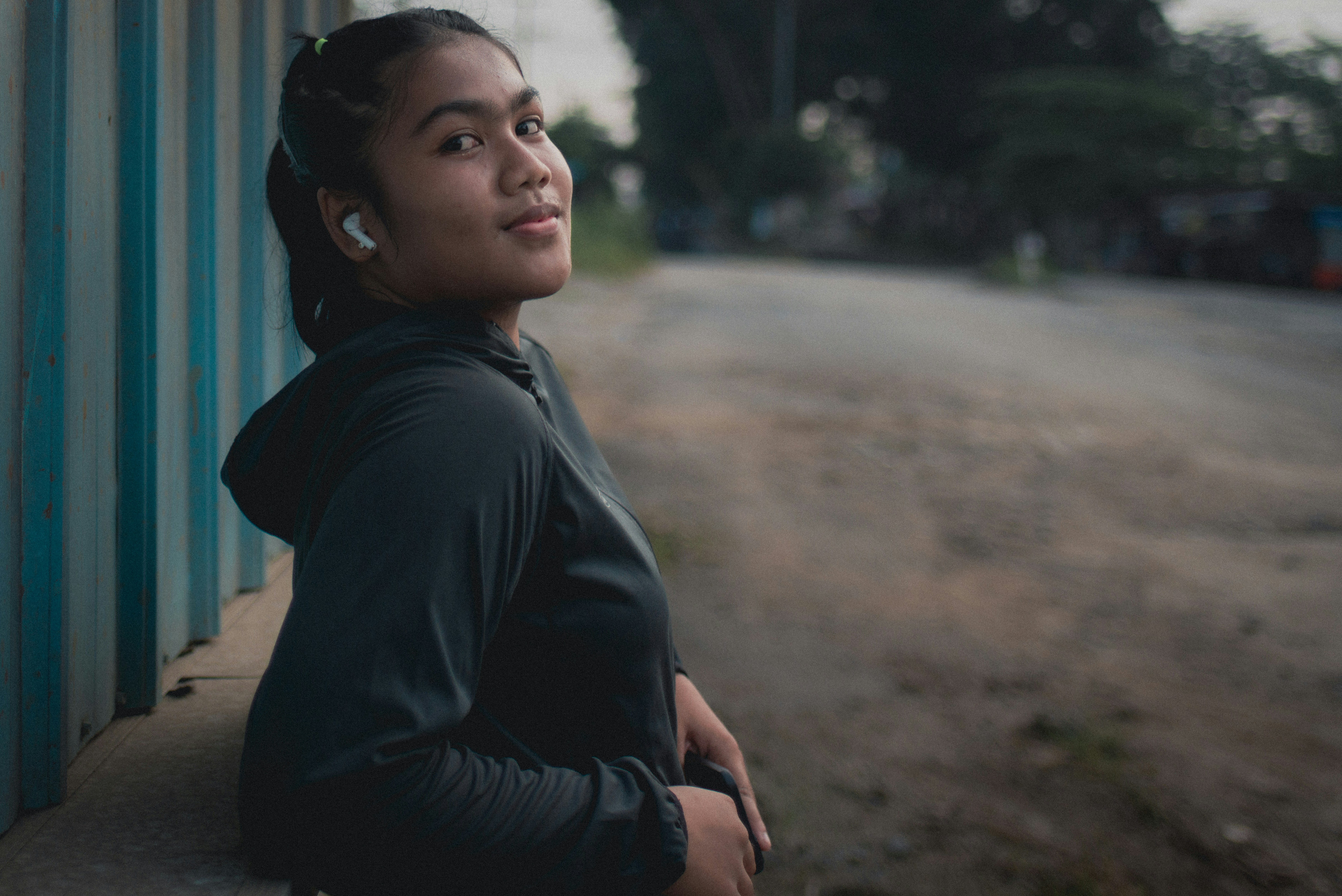 Quiet Confidence: Portrait by the Wall