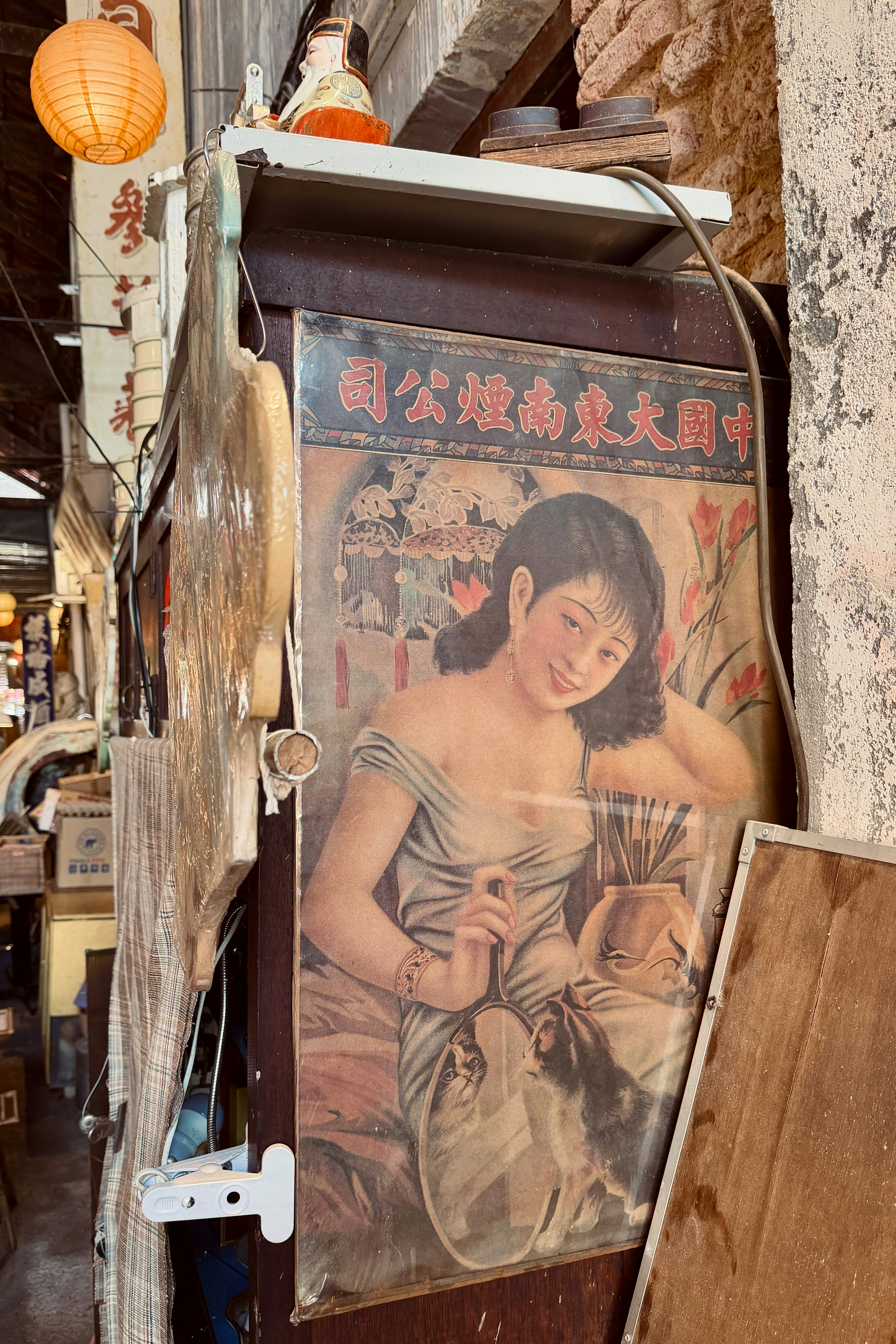 Vintage poster shop doorway with a painted woman advertising incense