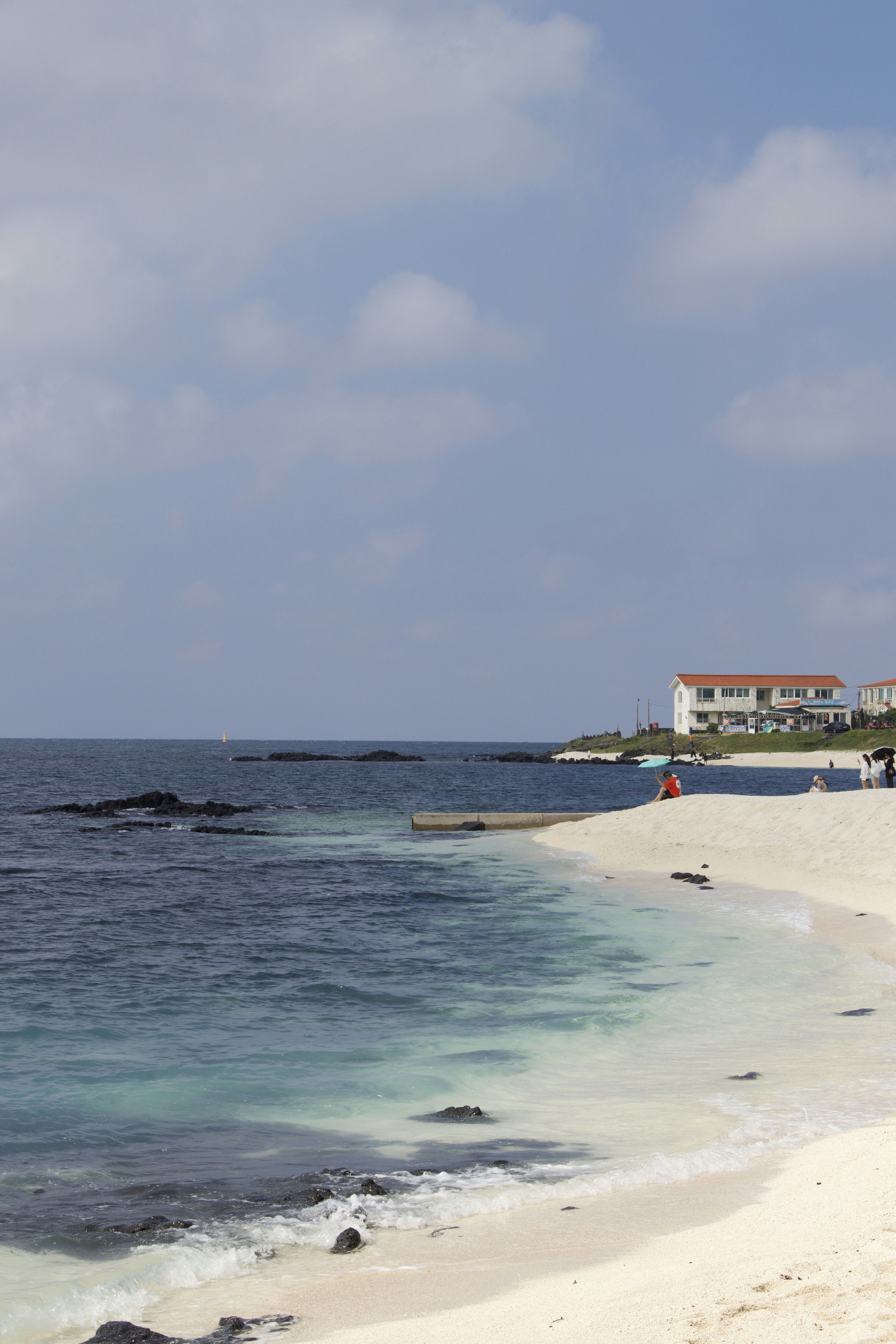 Sunlit Crescent: A Quiet Beachfront with Gentle Lapping Waves
