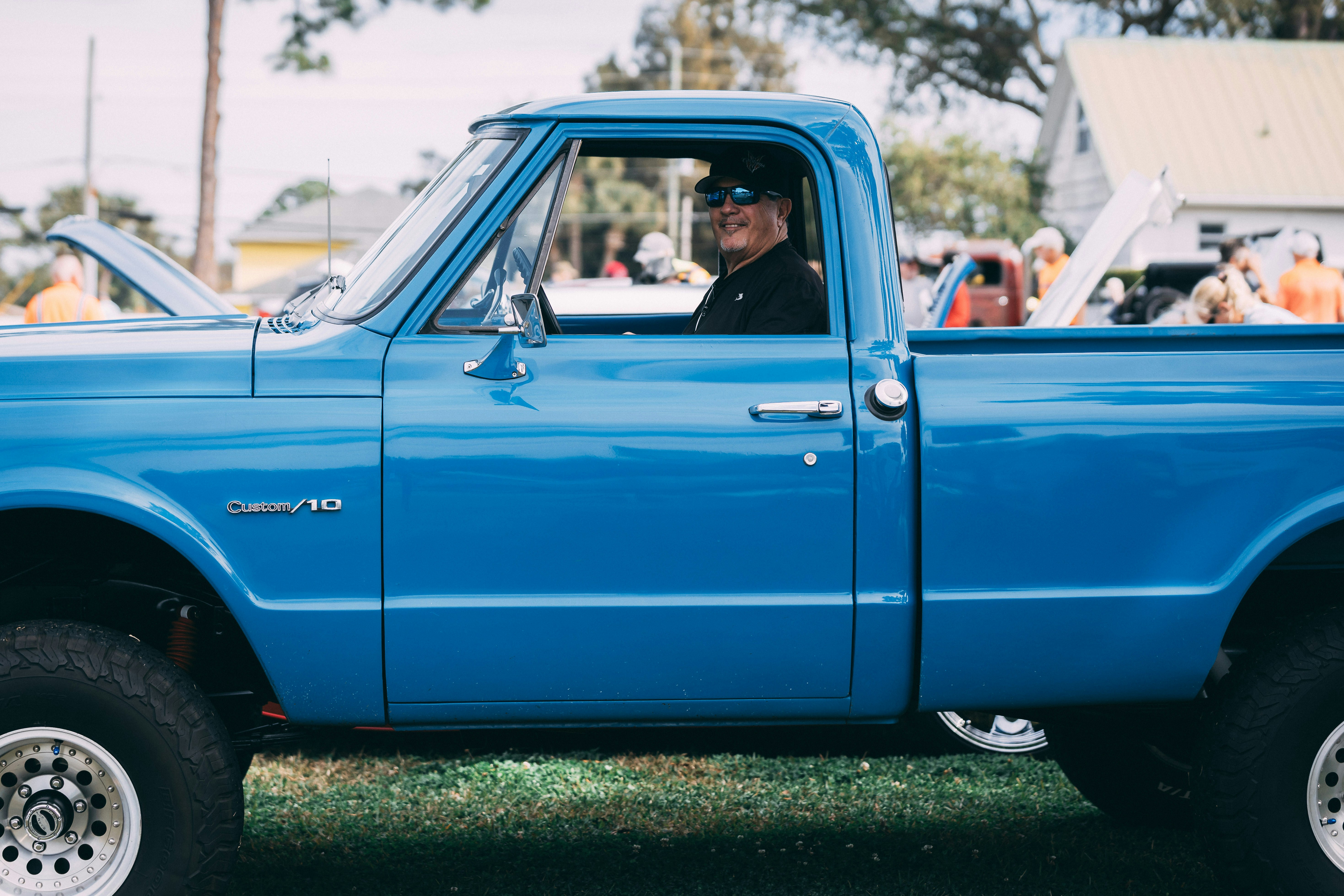 Blue Pickup in a Crowd: The Driver’s Quiet Moment