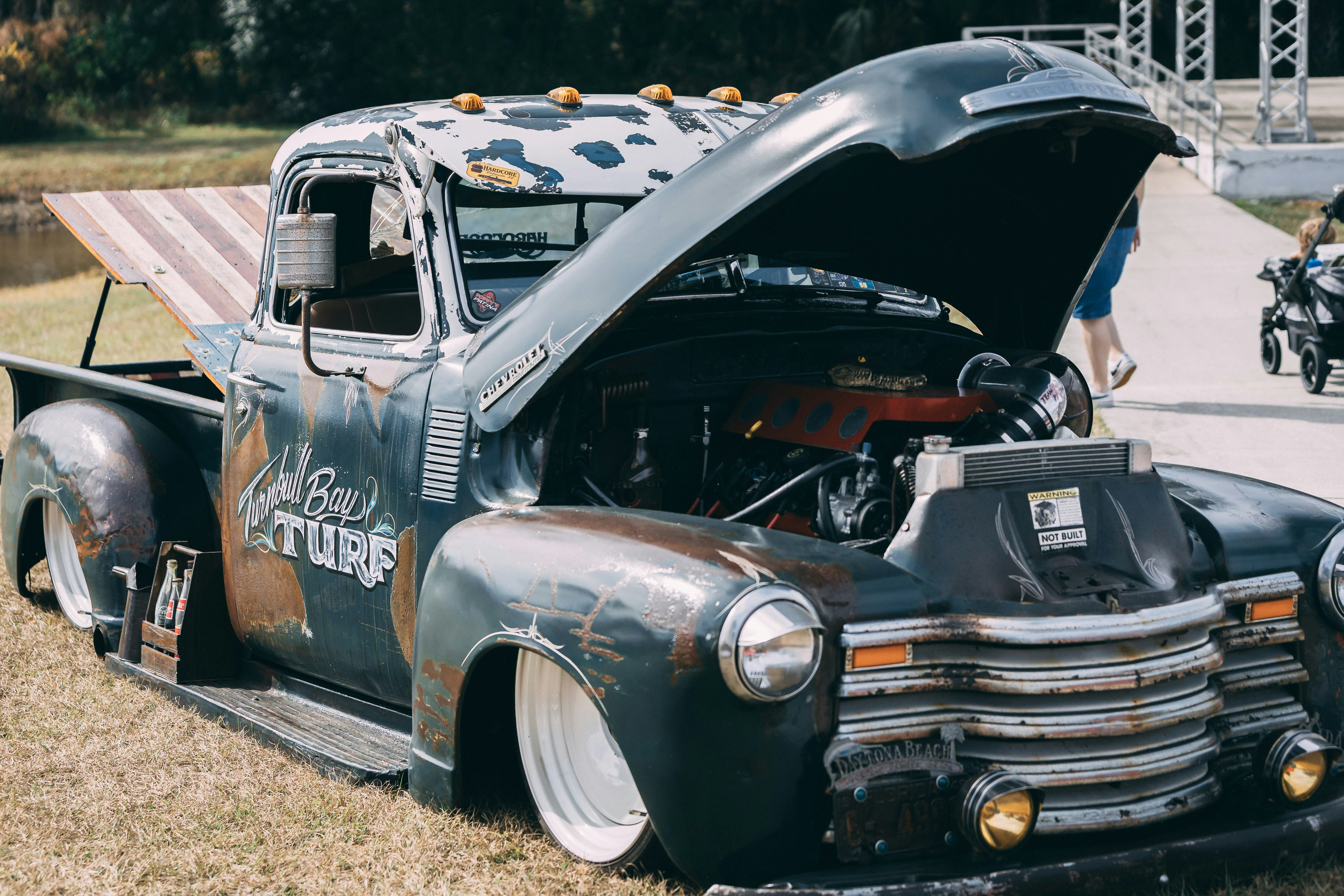 Vintage Pickup Parade: The Rusted Muscle with Open Hood