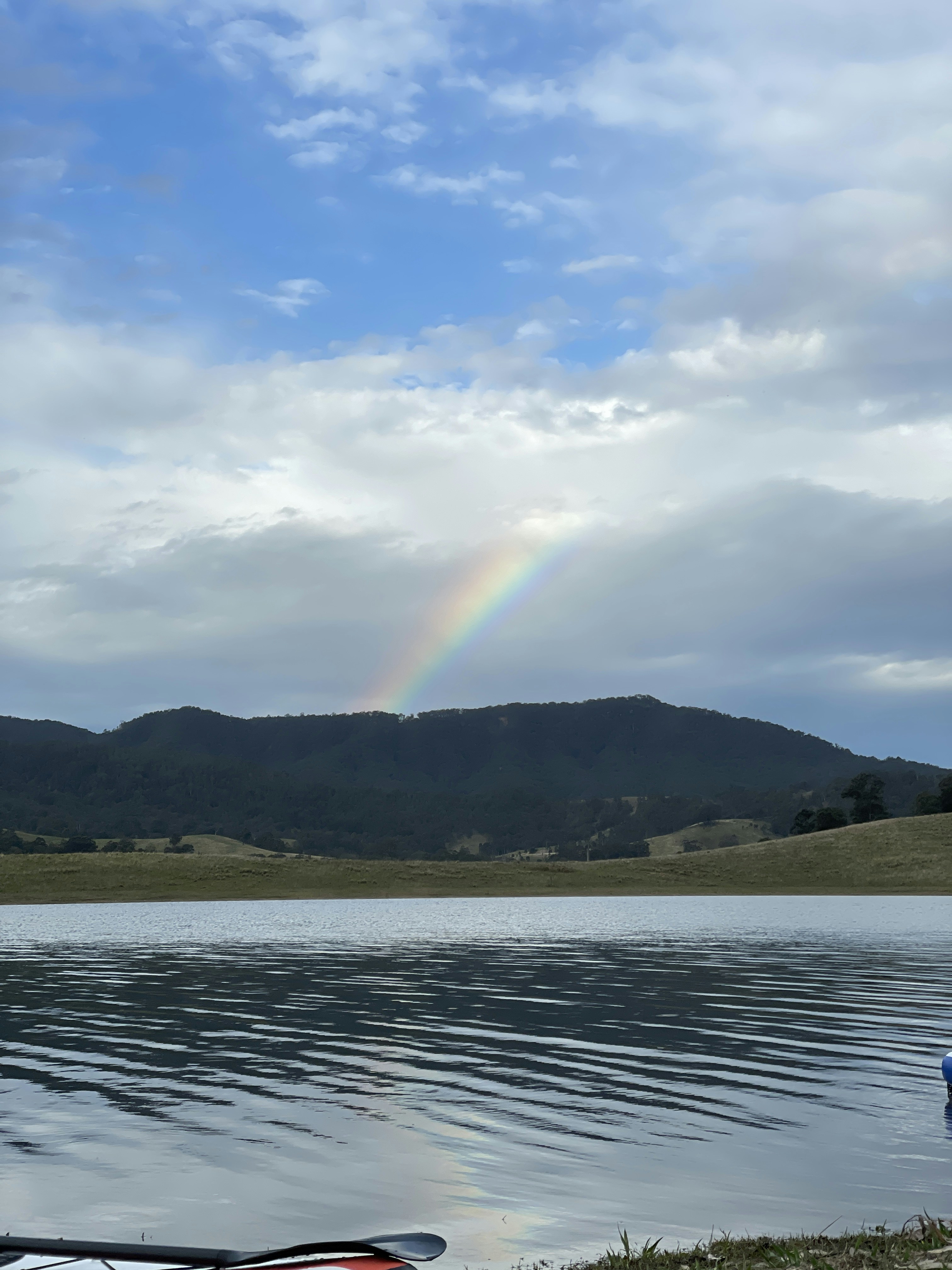 Rainbow Over Quiet Lake: Dawn Above Rolling Hills