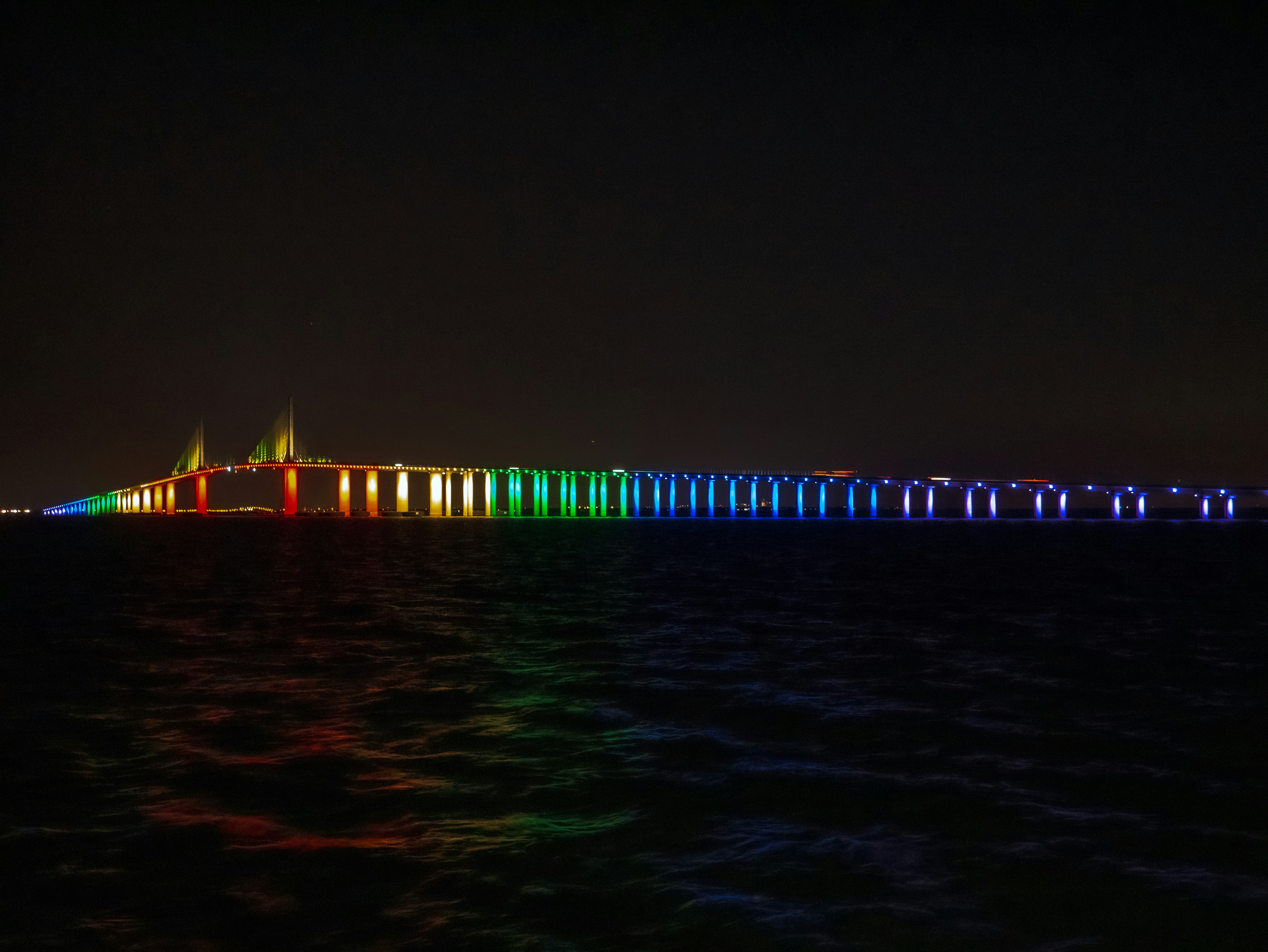 Rainbow Arc: Nighttime Lights Across the Water