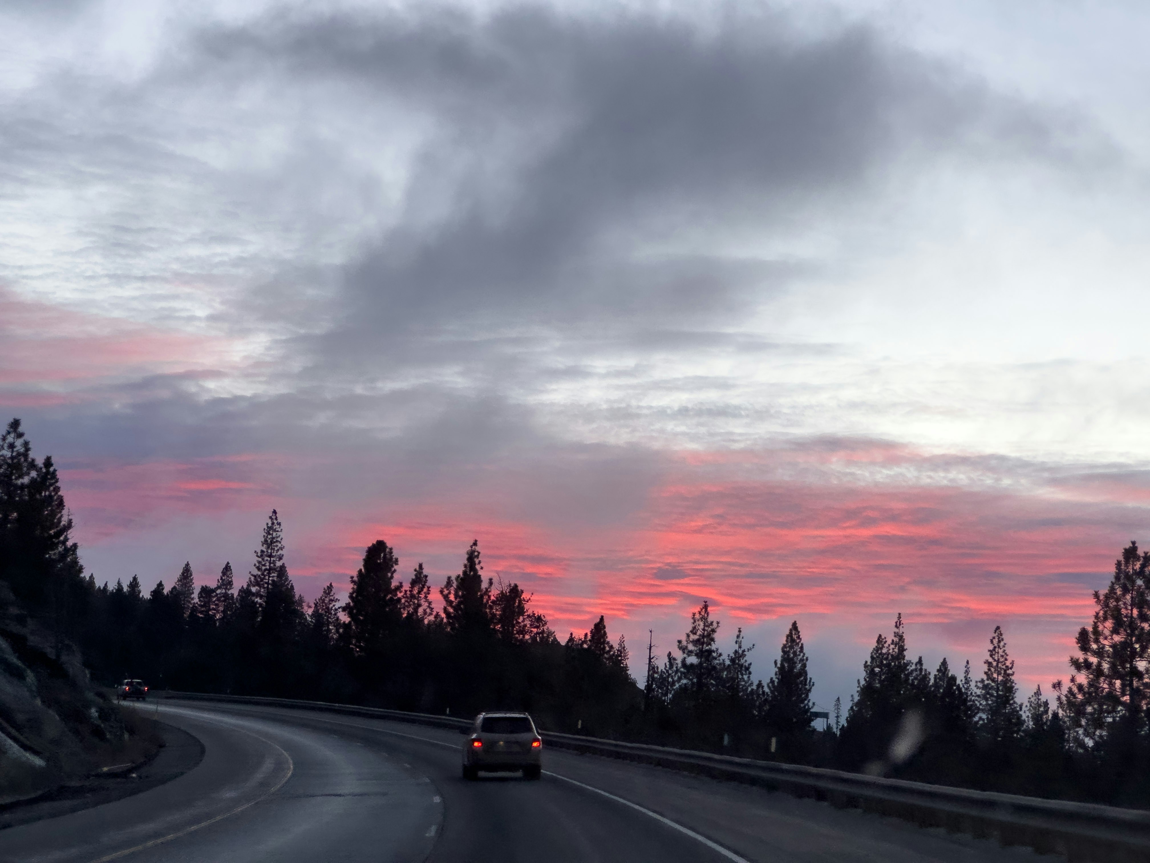 Twilight Curve: A Quiet Road Beneath Pink-tinged Clouds