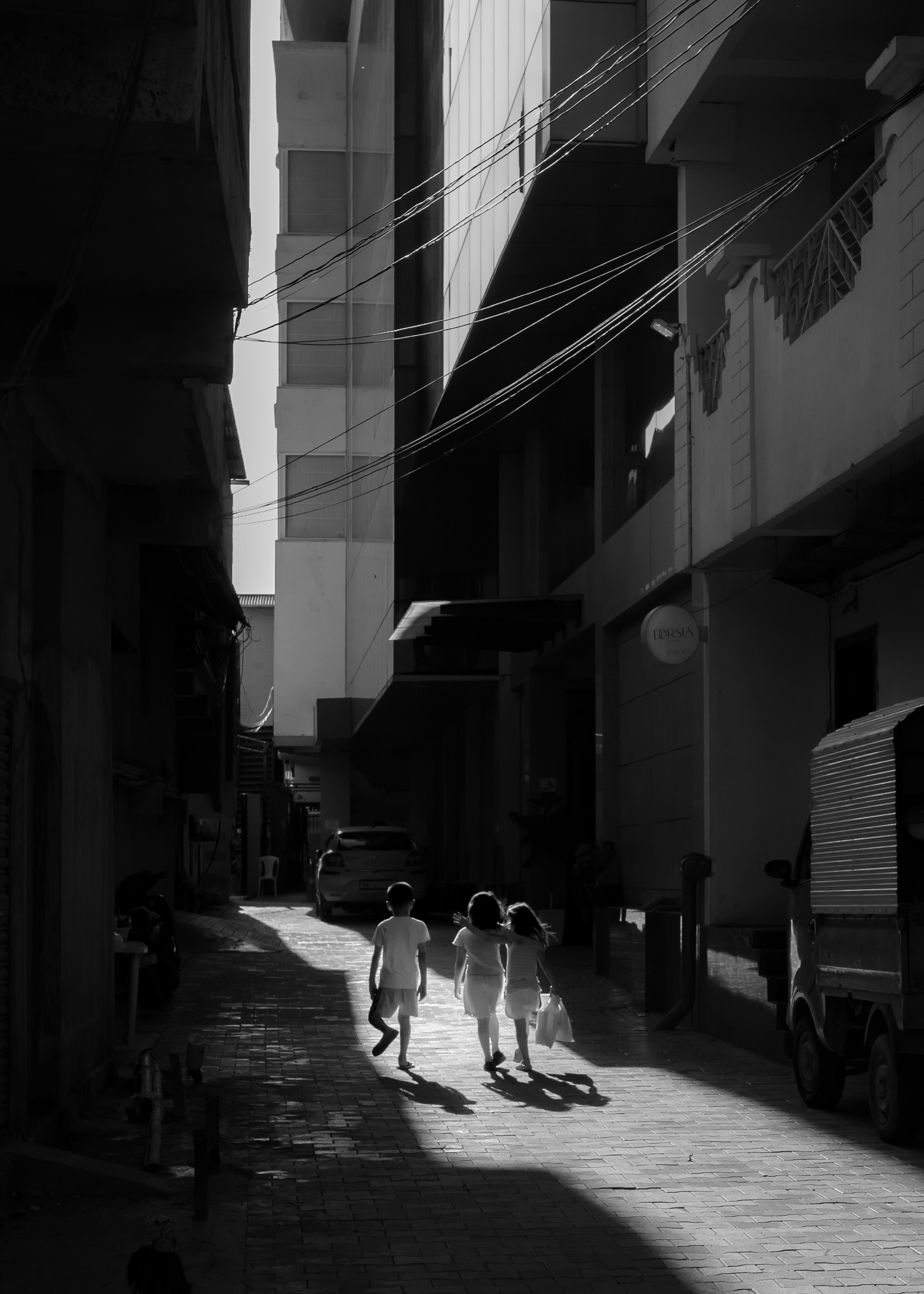 Children in a Sunlit Alley: A Quiet Upright Moment