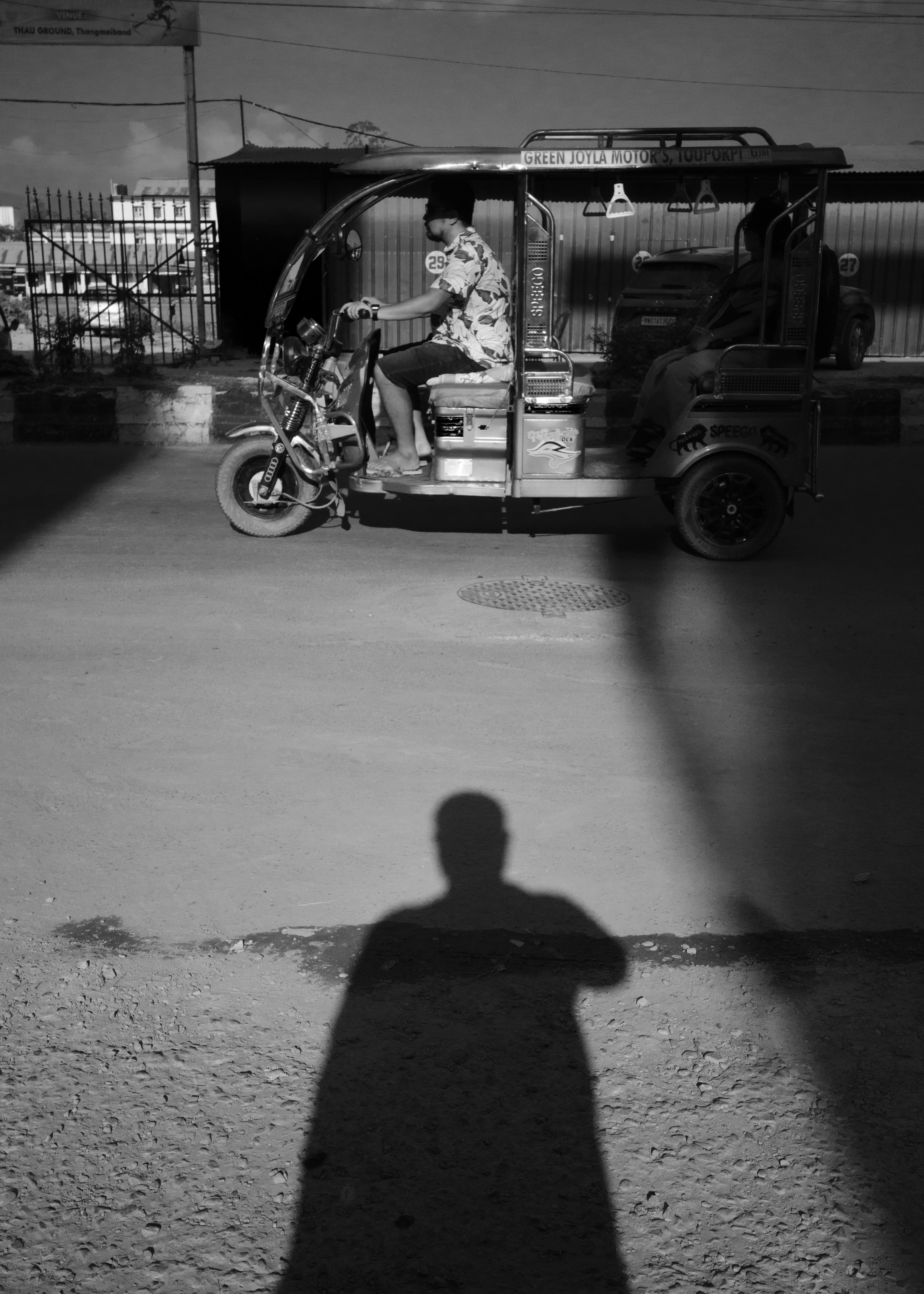 Shadowed Motoring: A Driver in a Sunlit Streetcar Moment