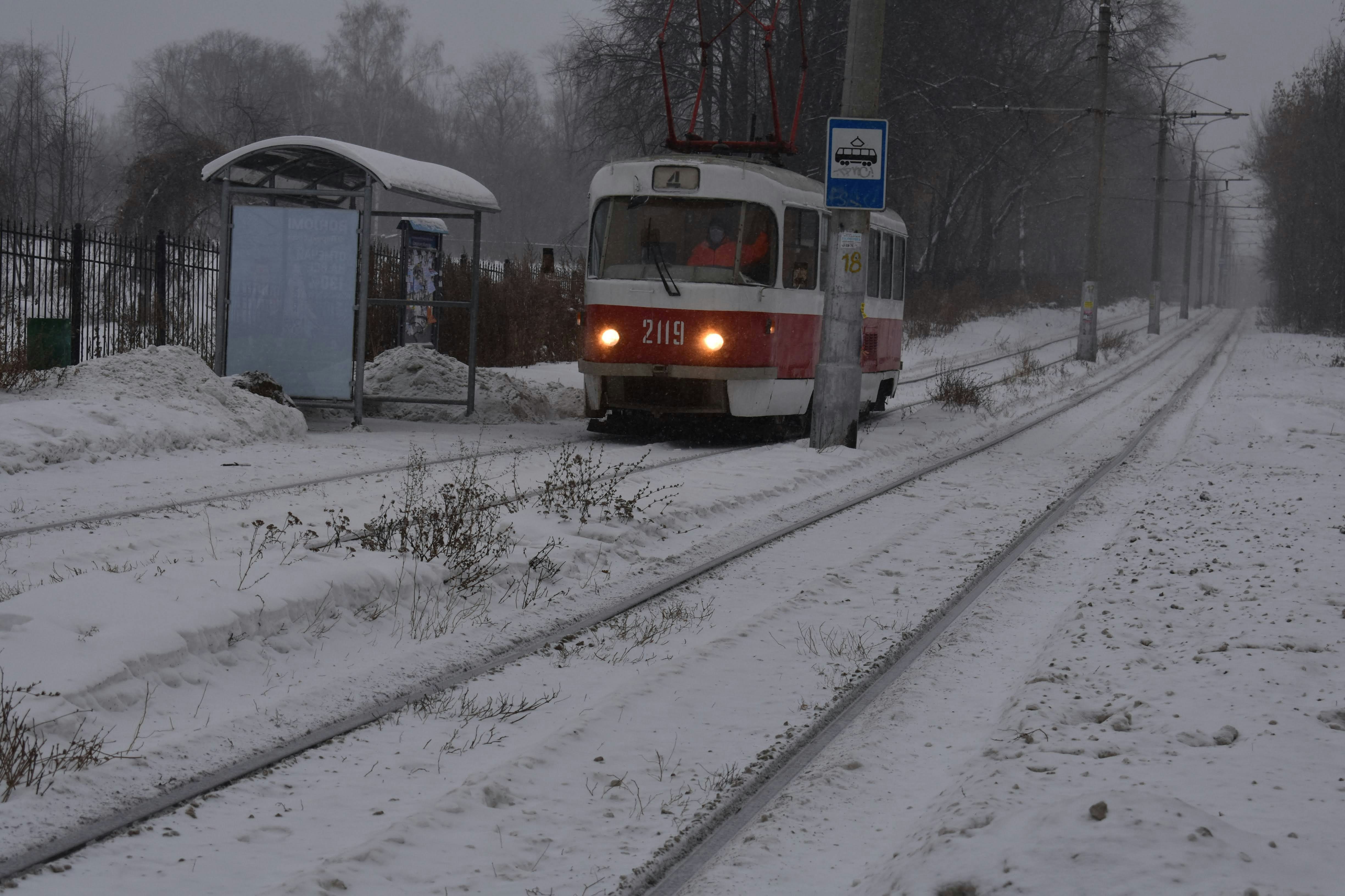 Winter tram at the snow-blanketed stop