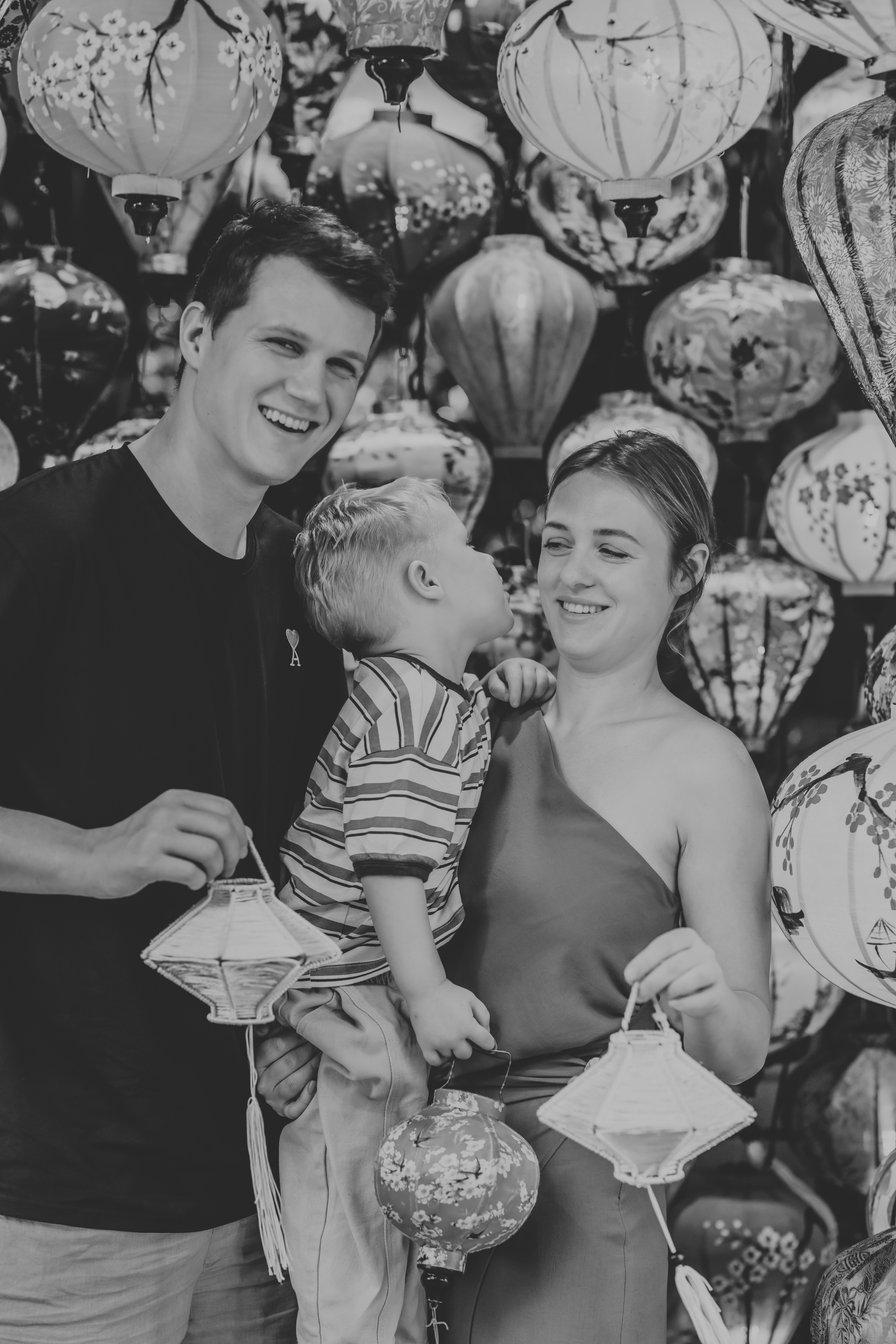 Joy Under Lanterns: A Family Moment Amid Floating Orbs