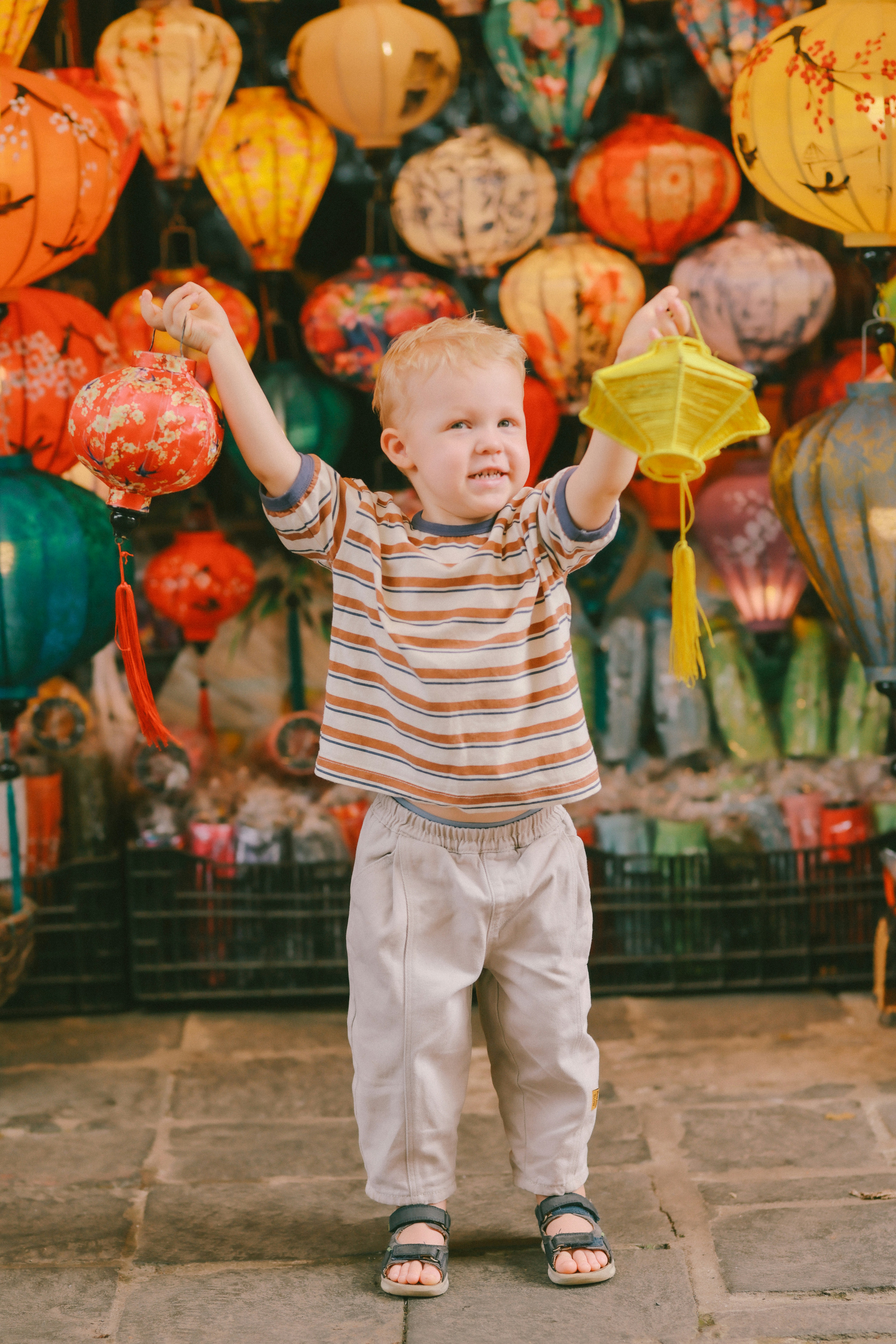 Joyful Lanterns: A Little Traveler Reaches for the Sky