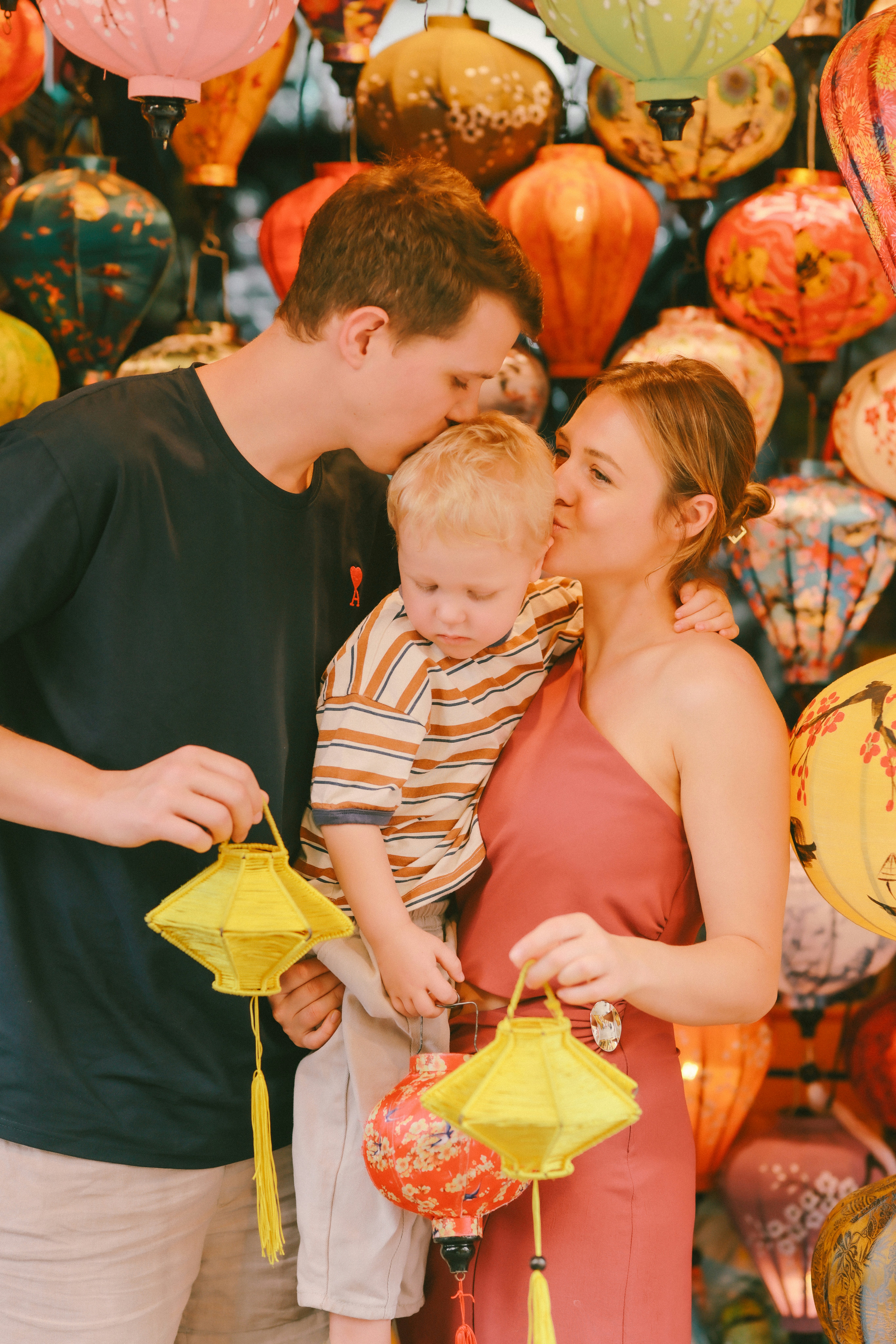 Families in a Lantern Market: A Tender Moment Under Colorful Orbs