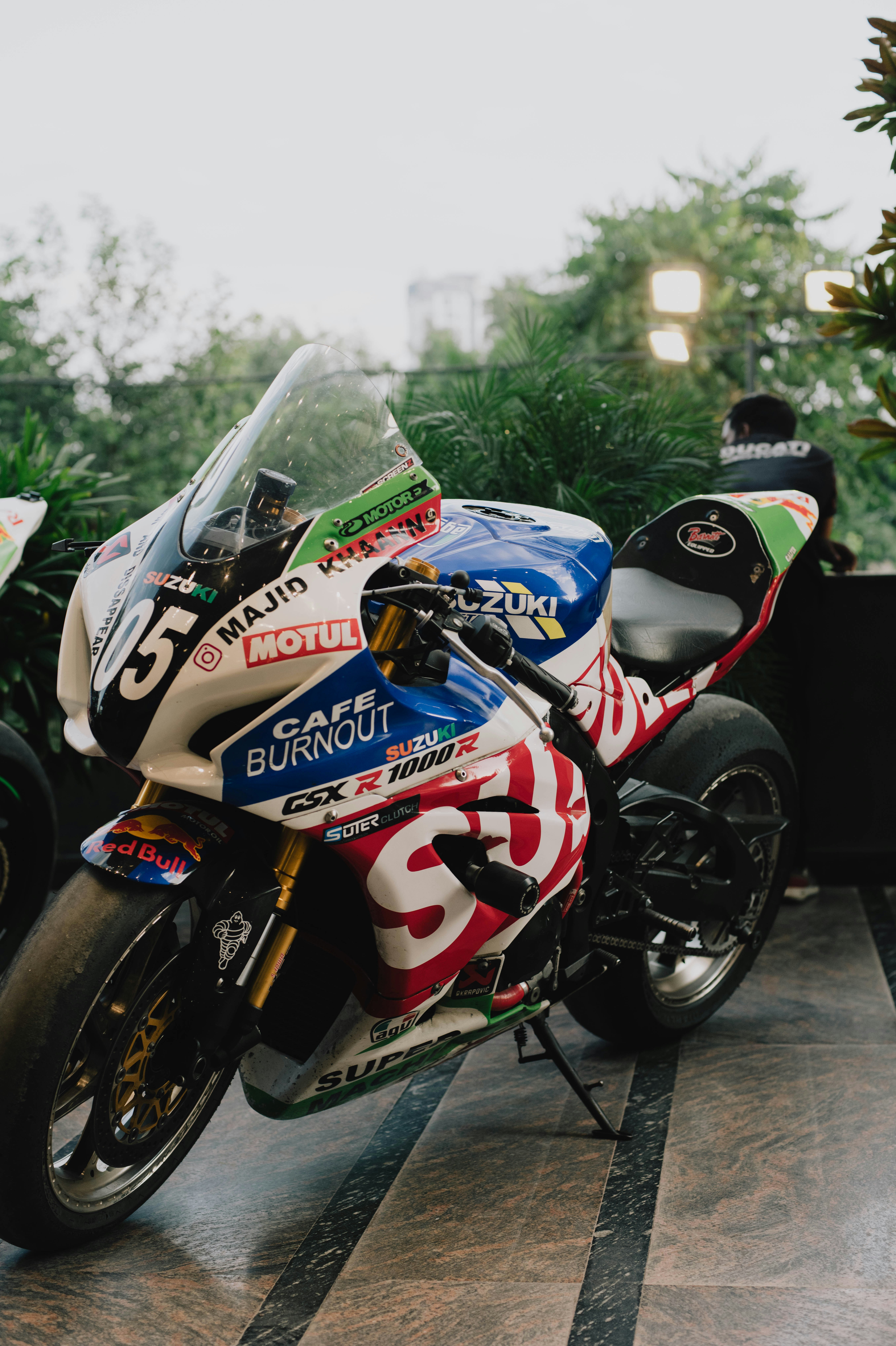 A colorful racing motorcycle parked outdoors.