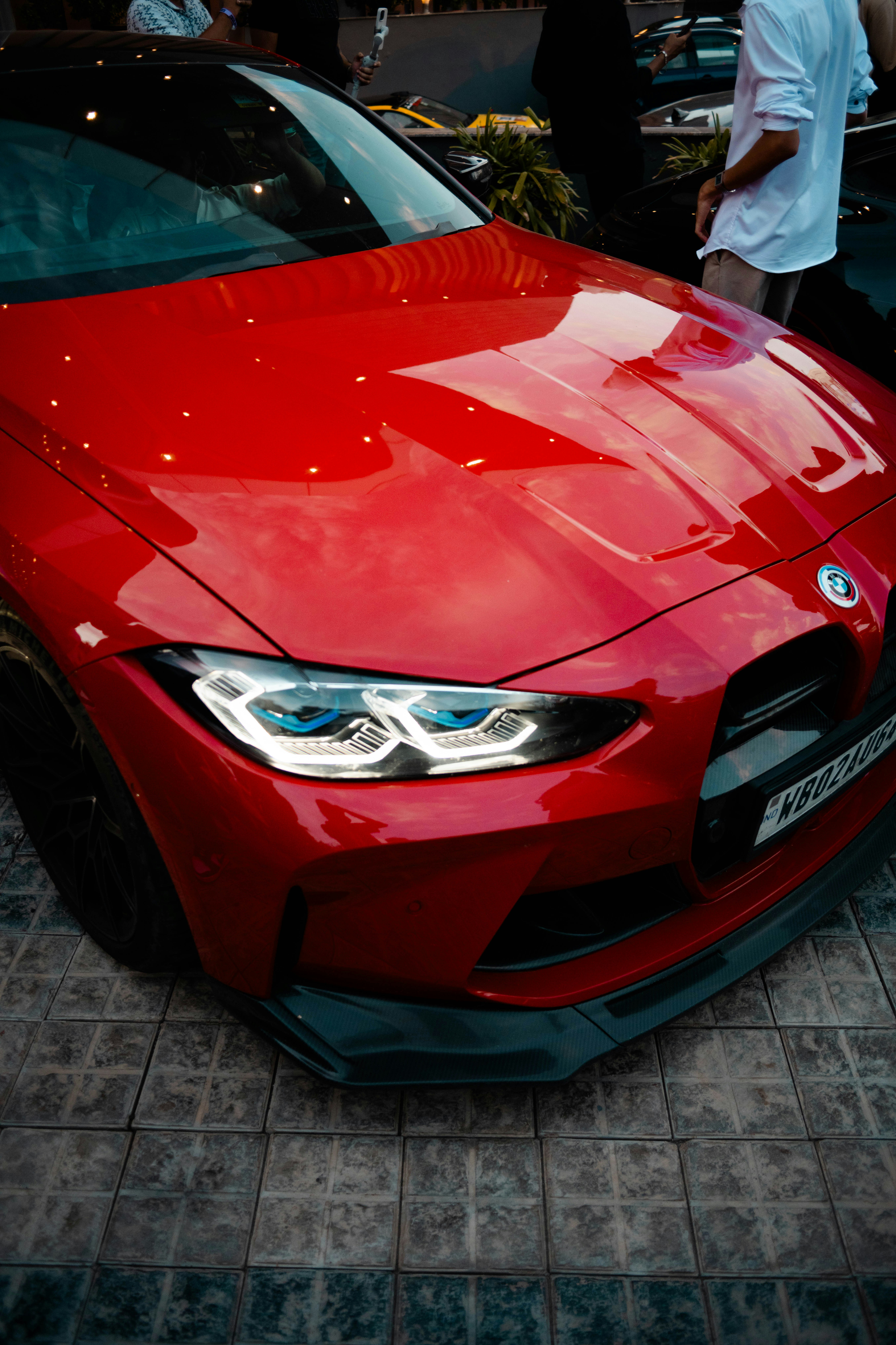 A shiny red BMW car with modern headlights.