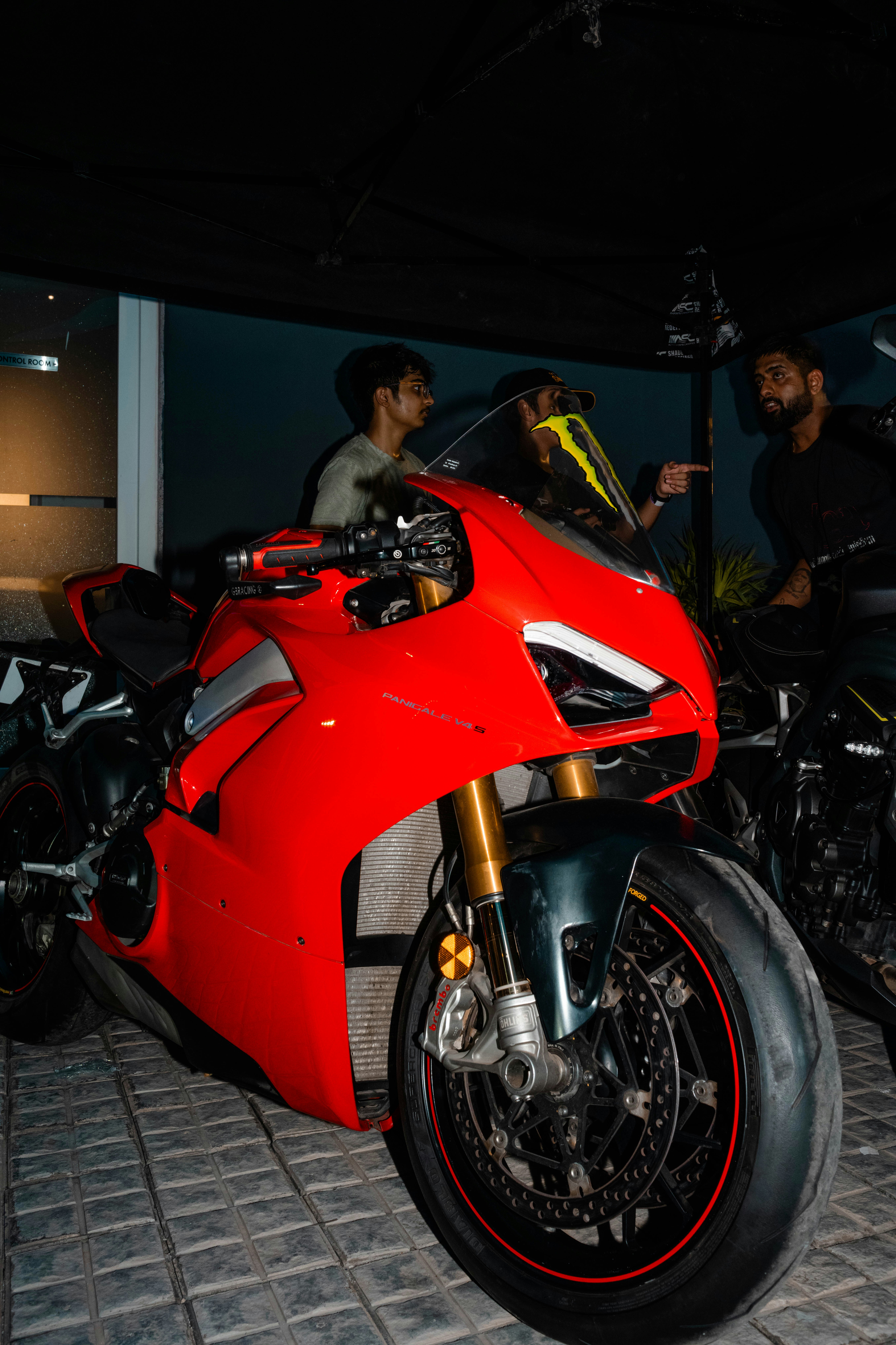 A bright red sport motorcycle parked outdoors at night