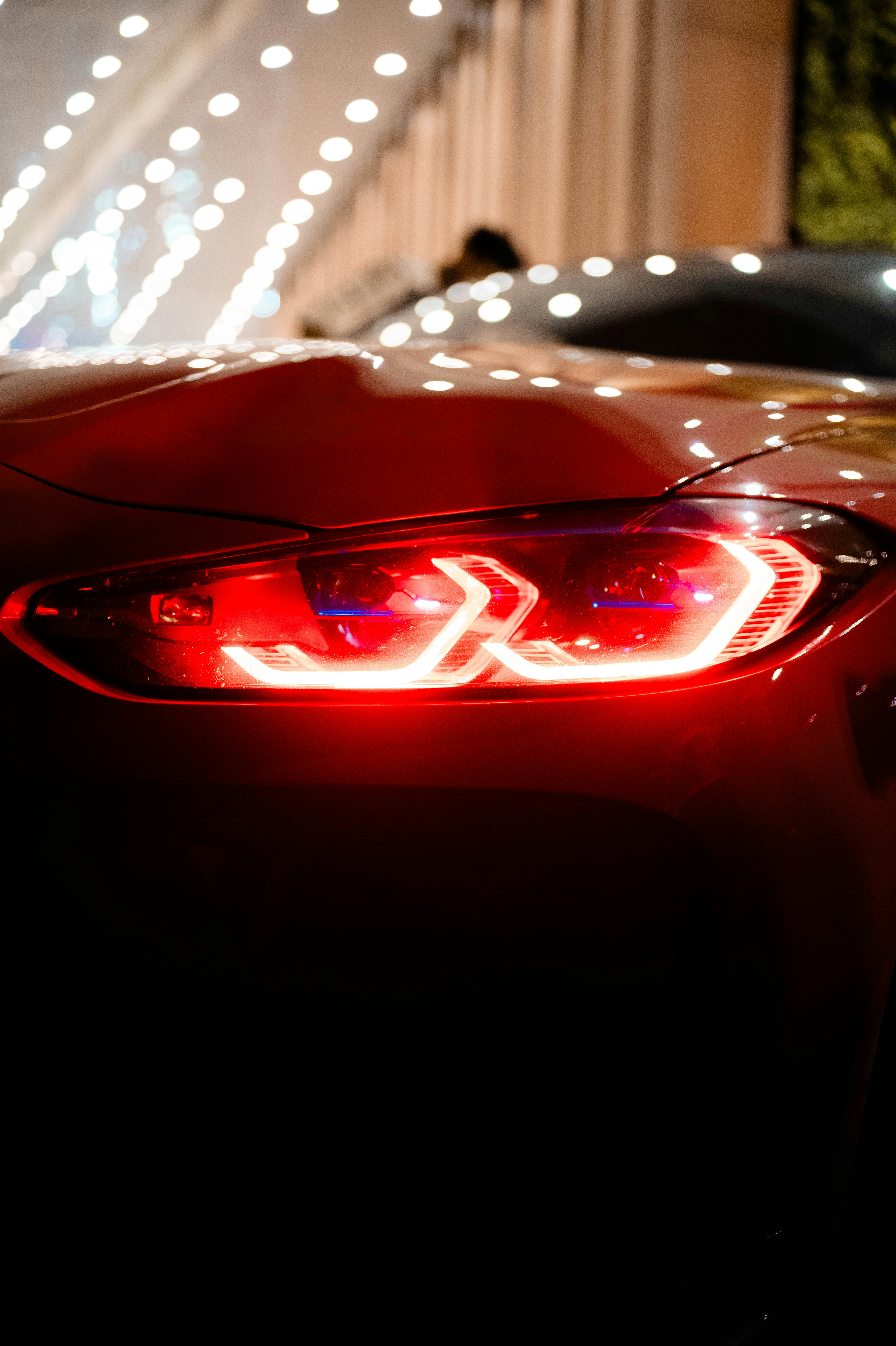 Close-up of a red car's glowing taillight at night