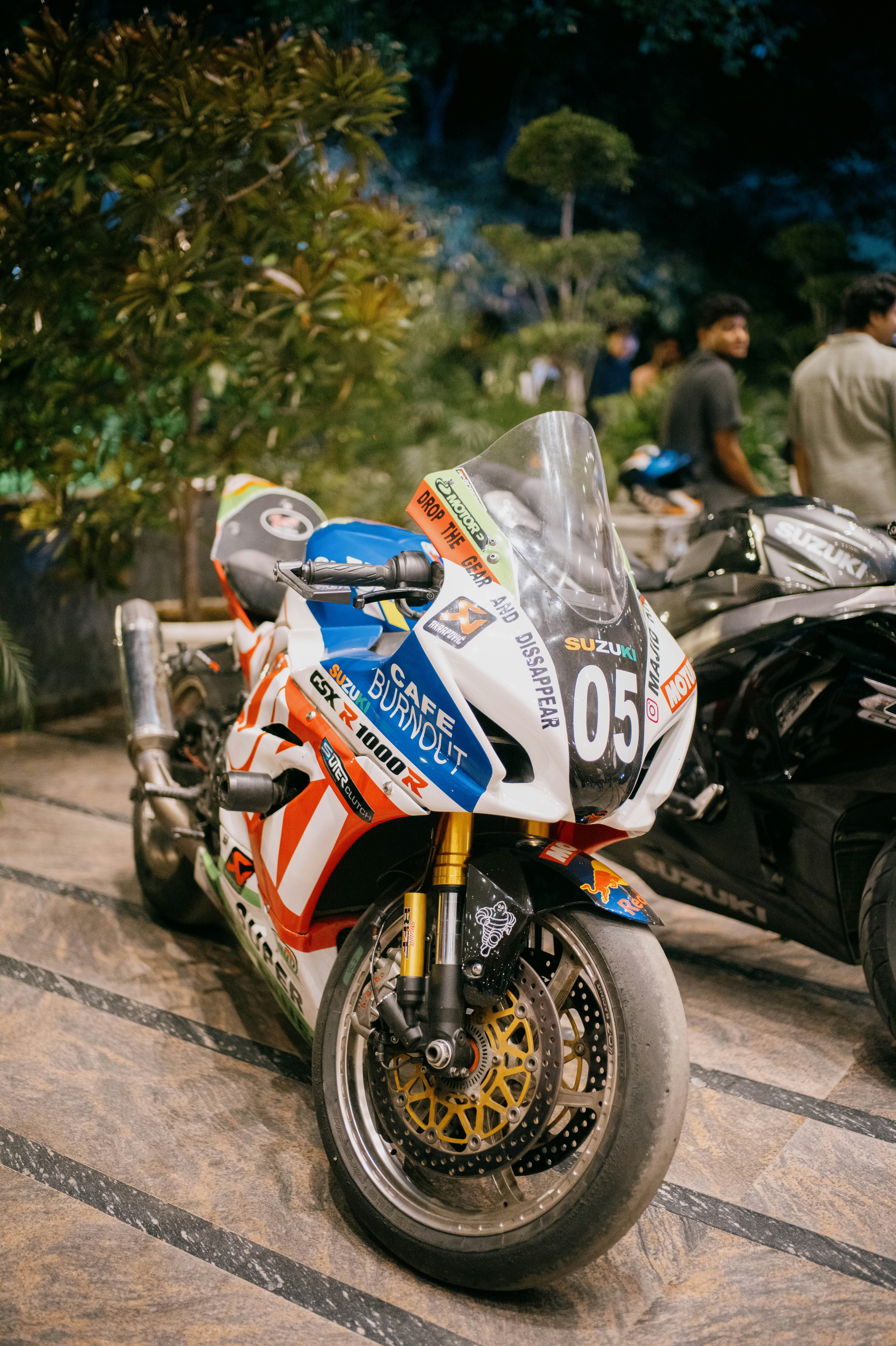 A white and red racing motorcycle parked outdoors.