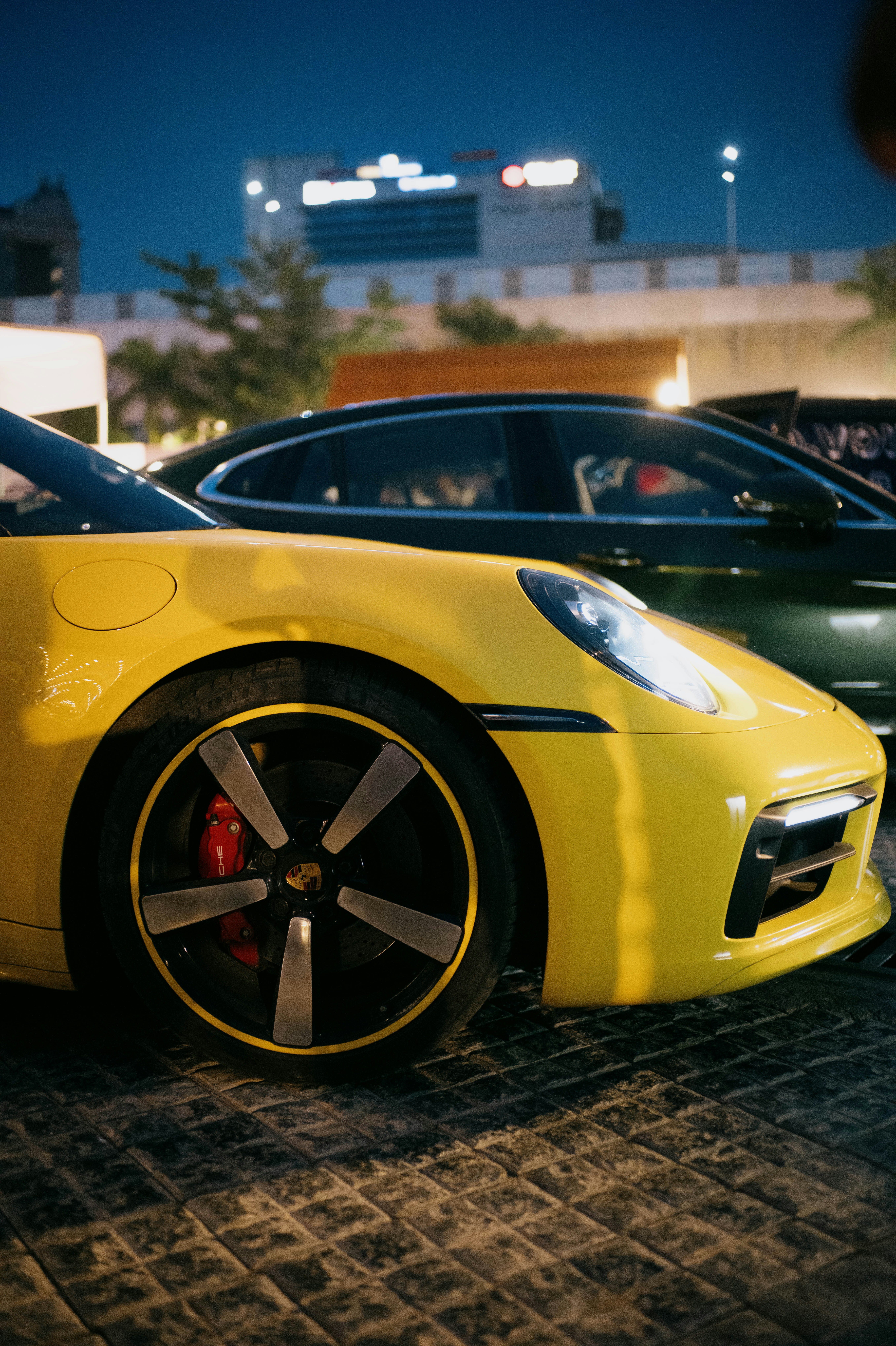 Yellow sports car parked on cobblestone street