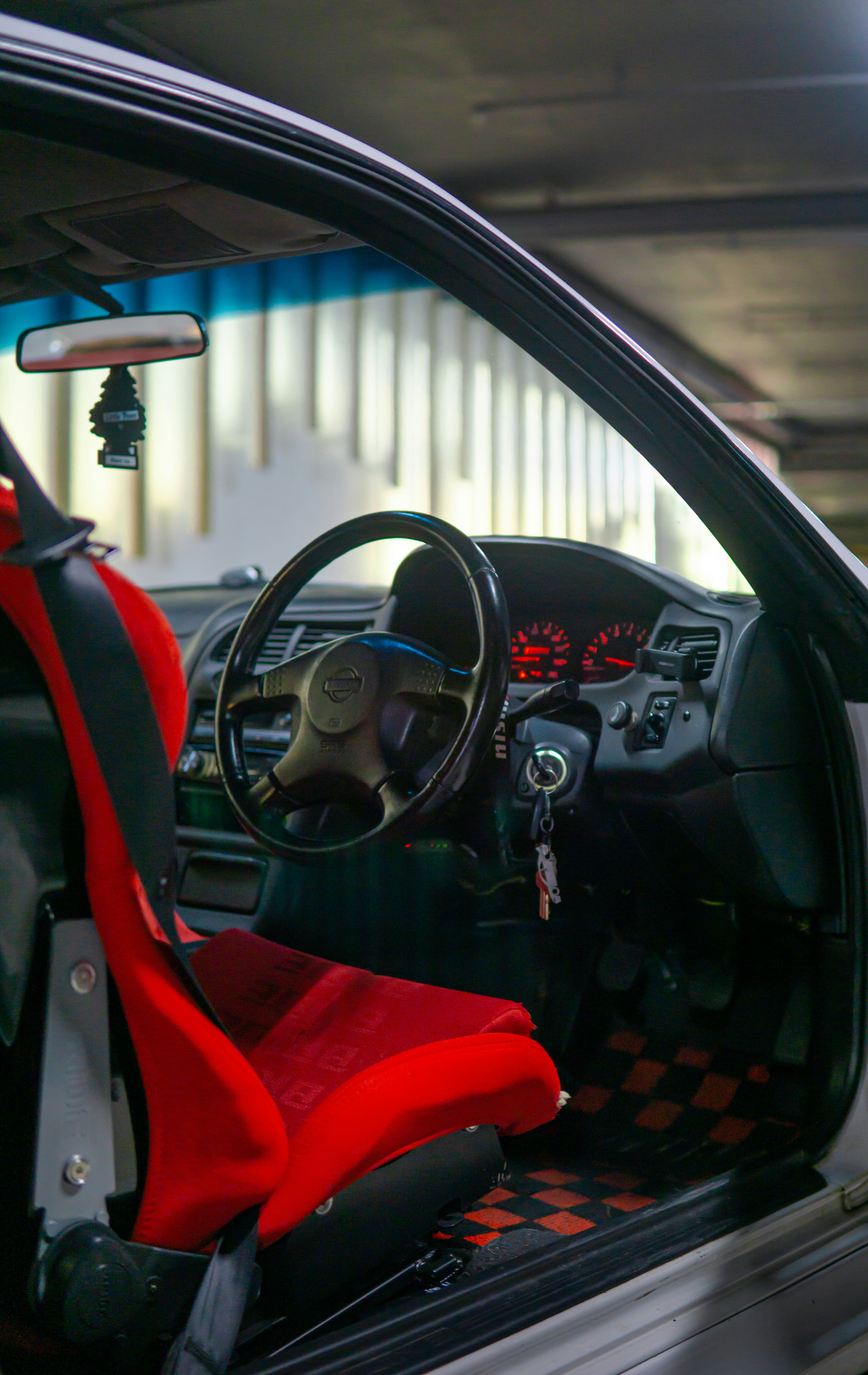 Red Racing Seat and Steering Wheel: An Inside Look at a Classic Car