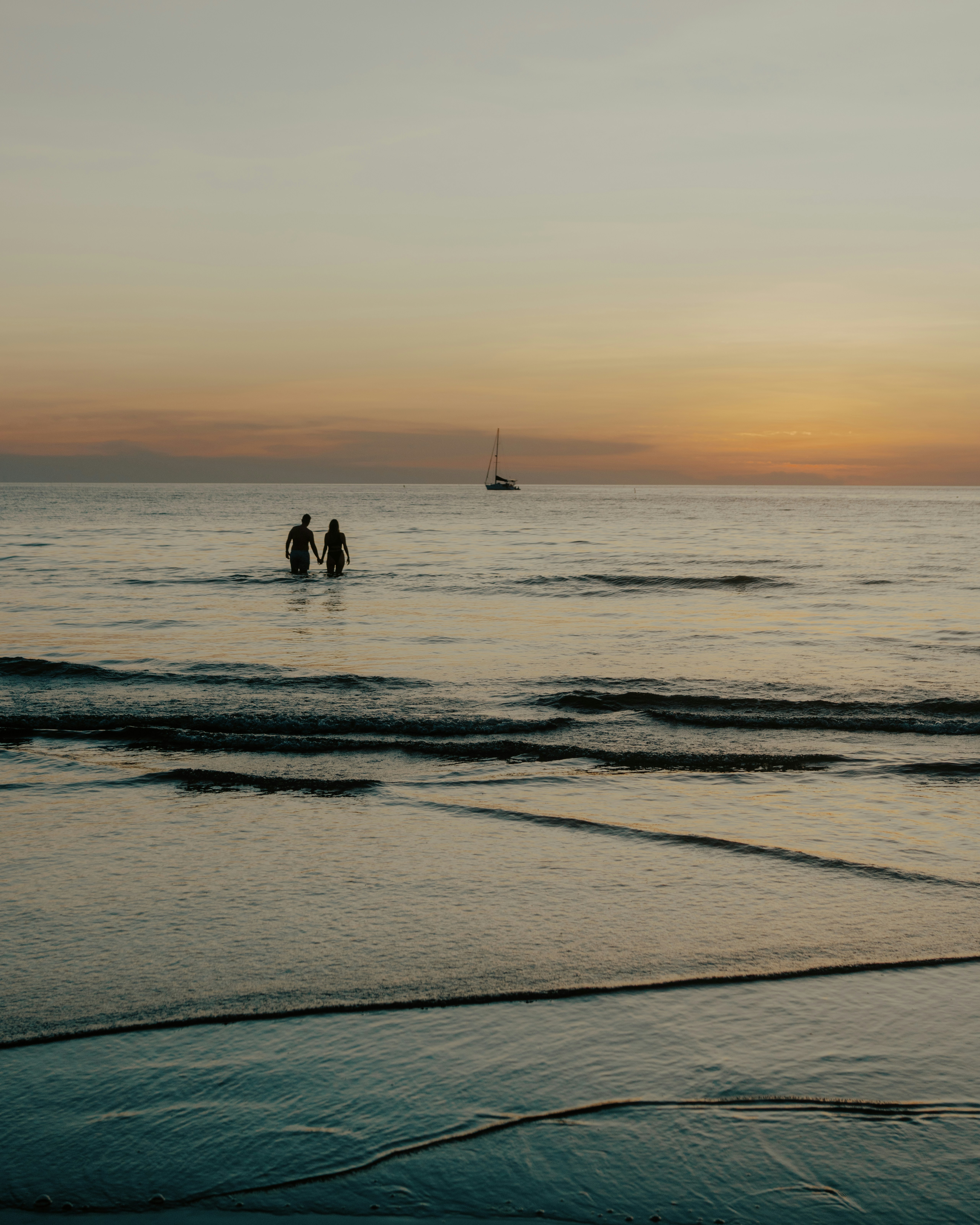 Evening Tides: silhouettes at sunset over a calm sea