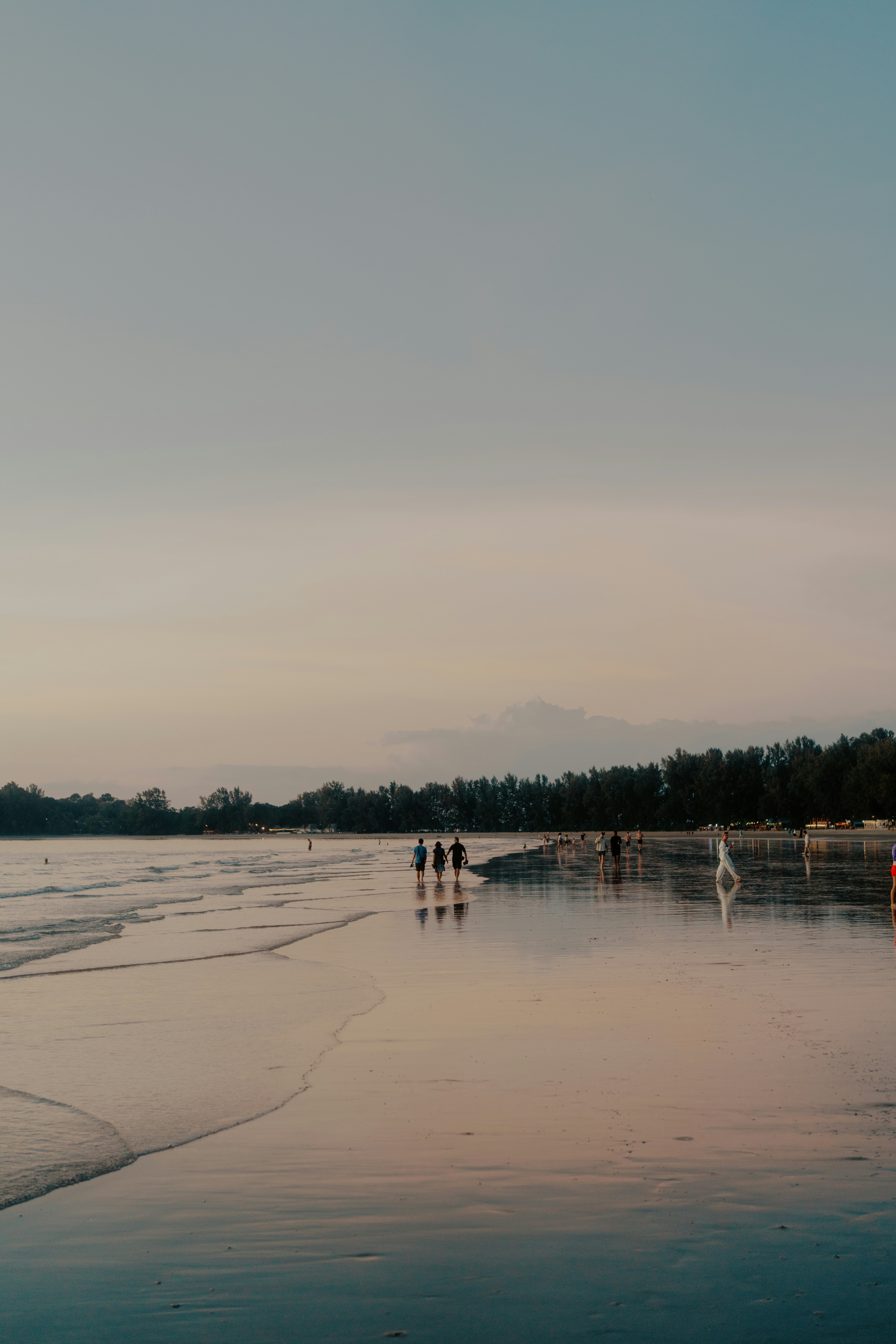Dusk on the Tidal Mirror: People and Shoreline at Sunset