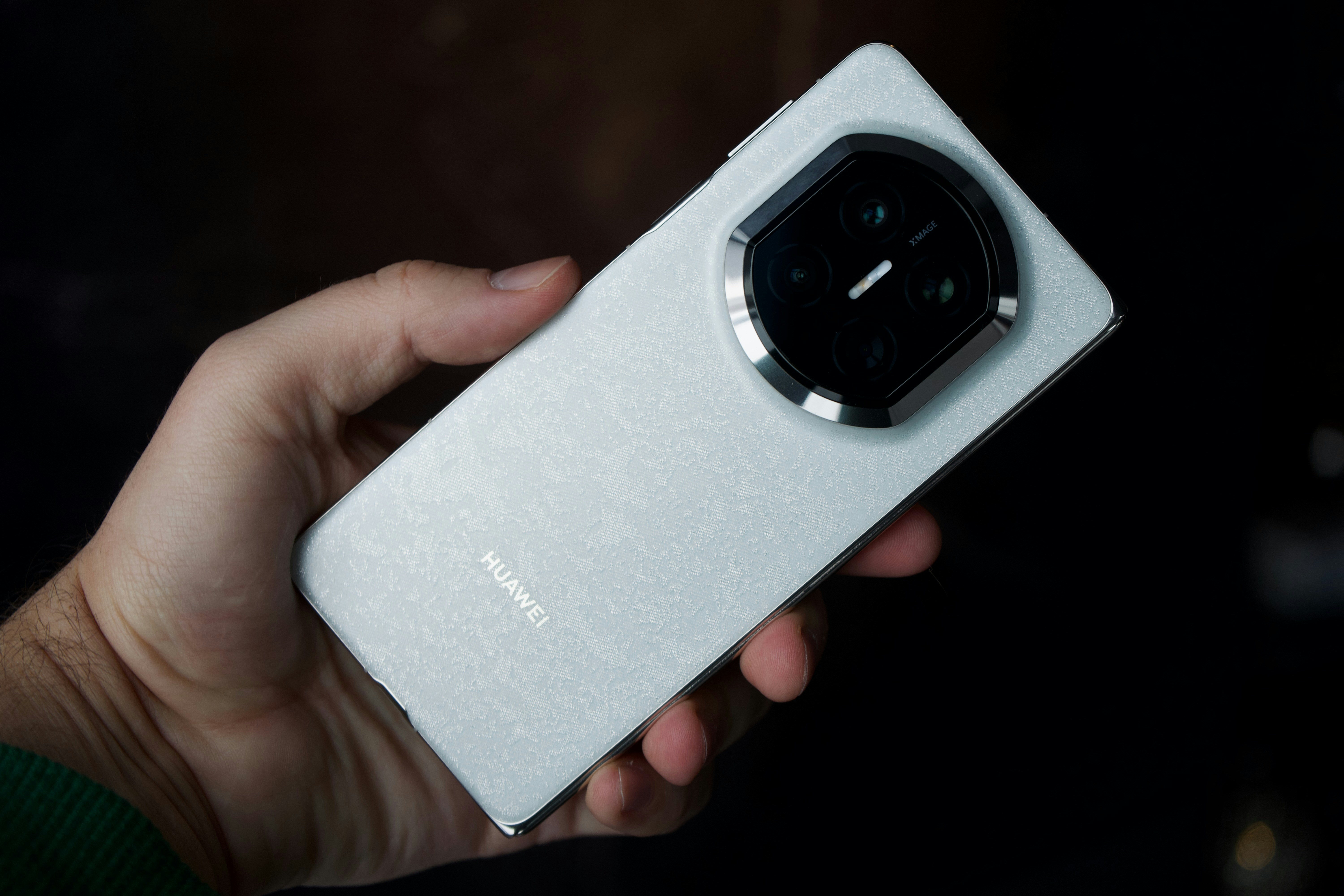 Pearl Pocket: A Pale Silver Huawei Grasped in a Gentle Hand