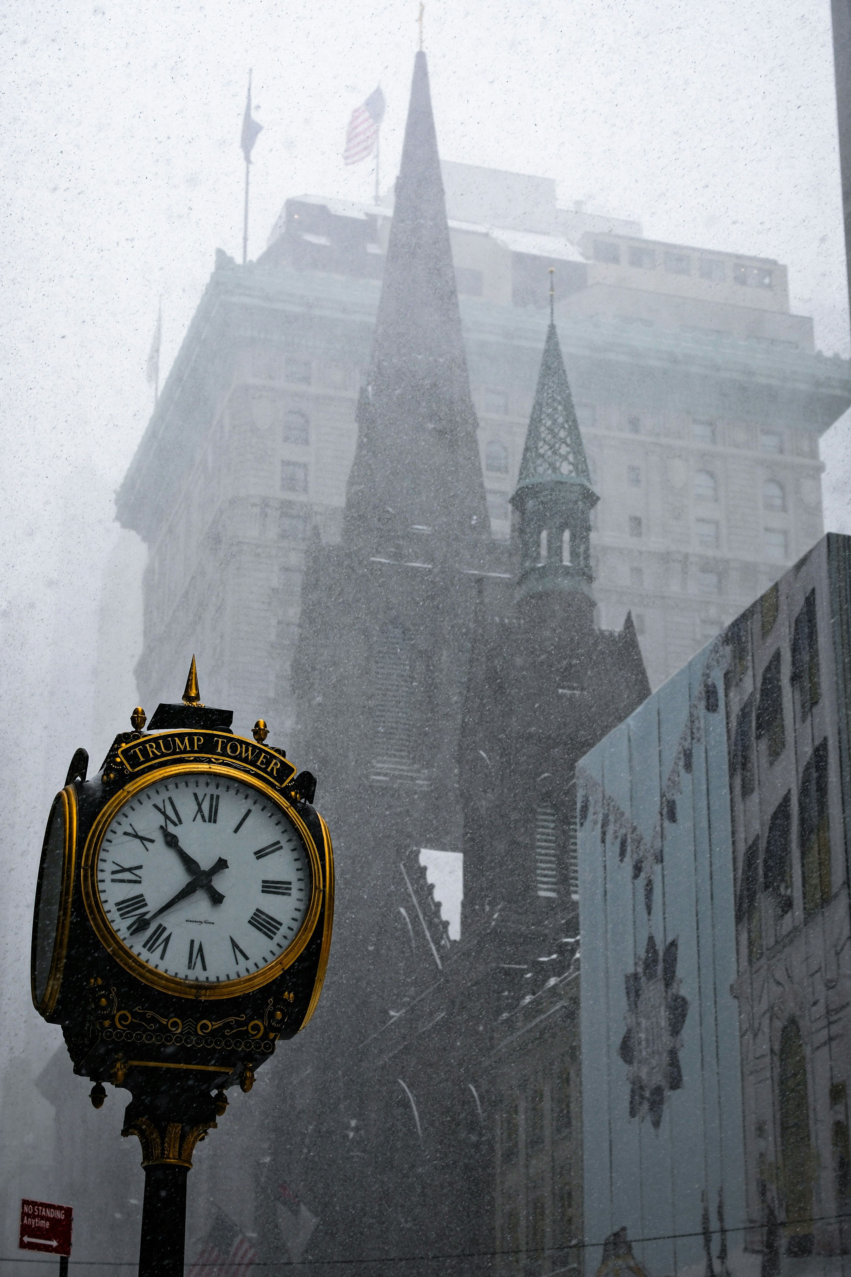 Clock at Dusk: Trump Tower Street Clock Amidst Snow and Skyscrapers