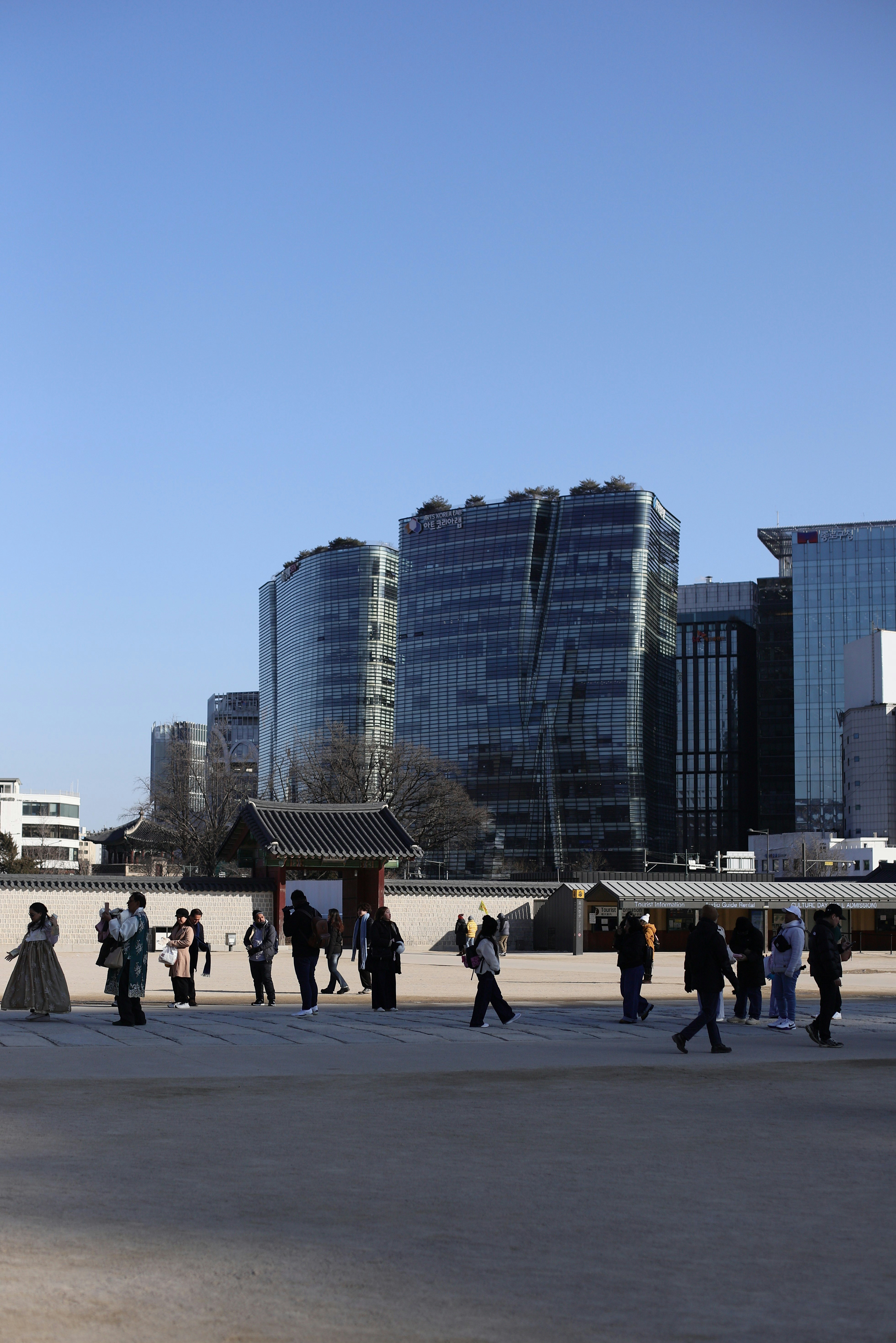 City Courtyard: People Walk Against a Modern Skyline