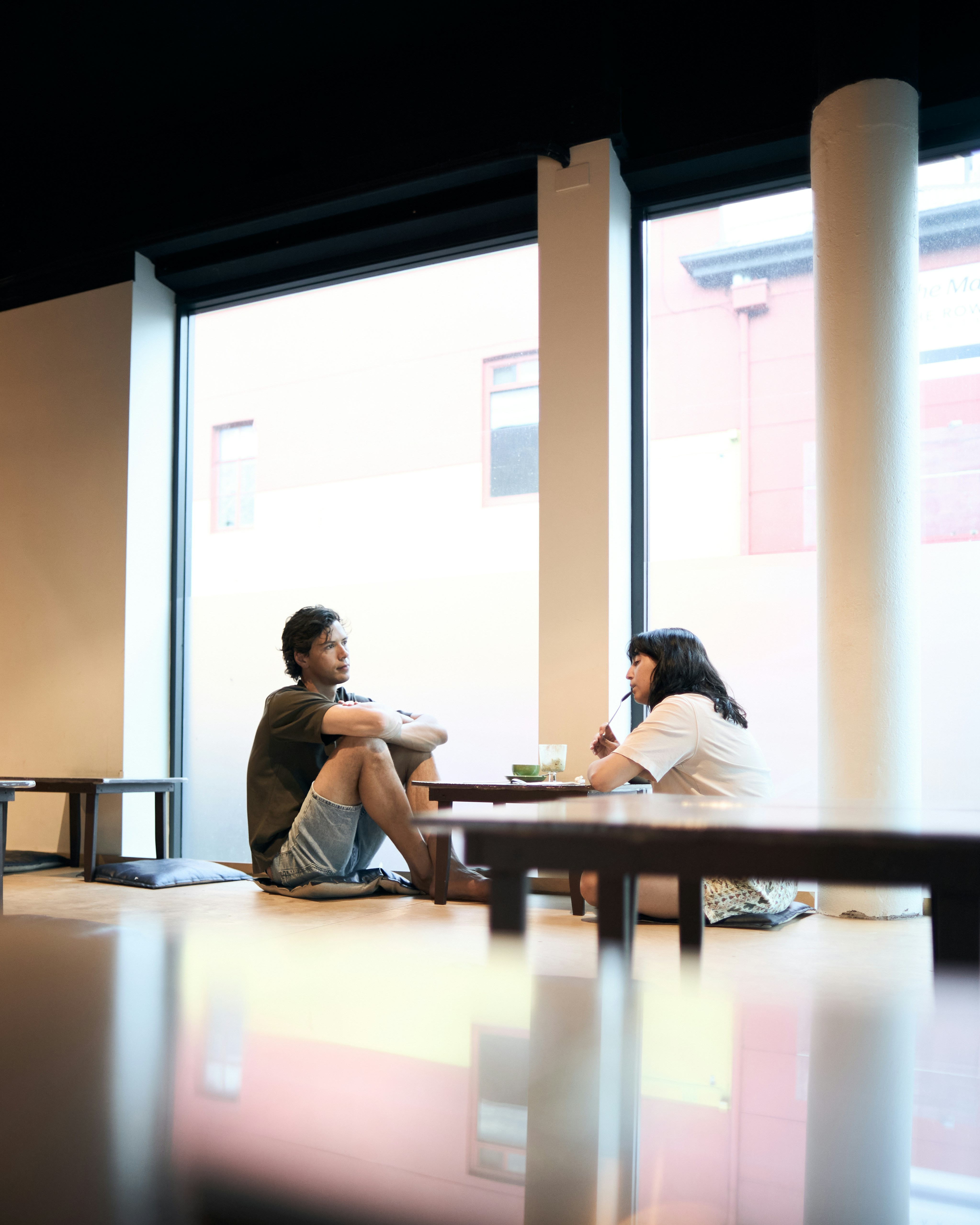 Quiet Exchange in a Sunlit Studio