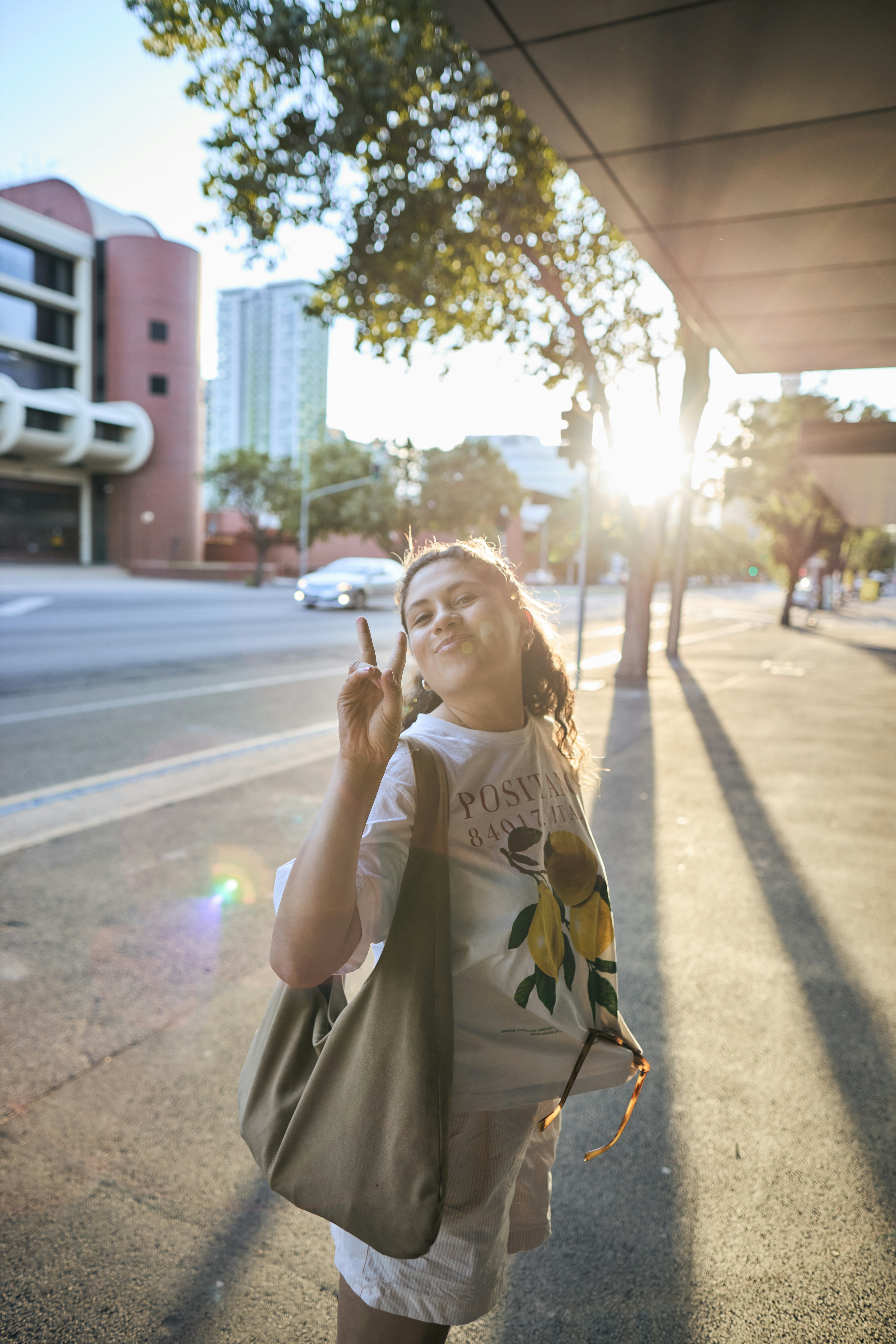 Sunlit Street Portrait: Peace Sign in the Golden Hour