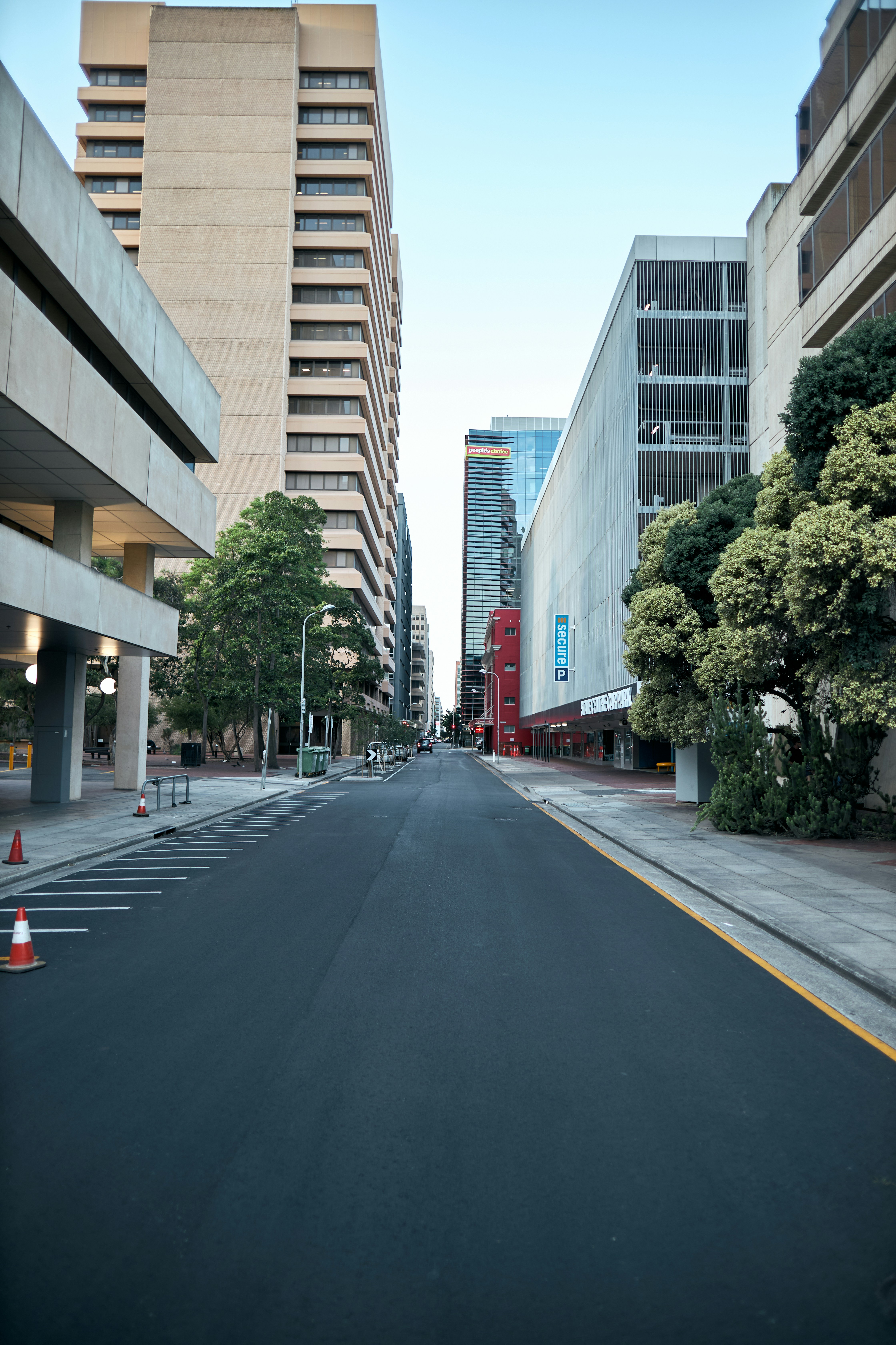 Urban Avenue Convergence: A Quiet City Street Framed by Towers