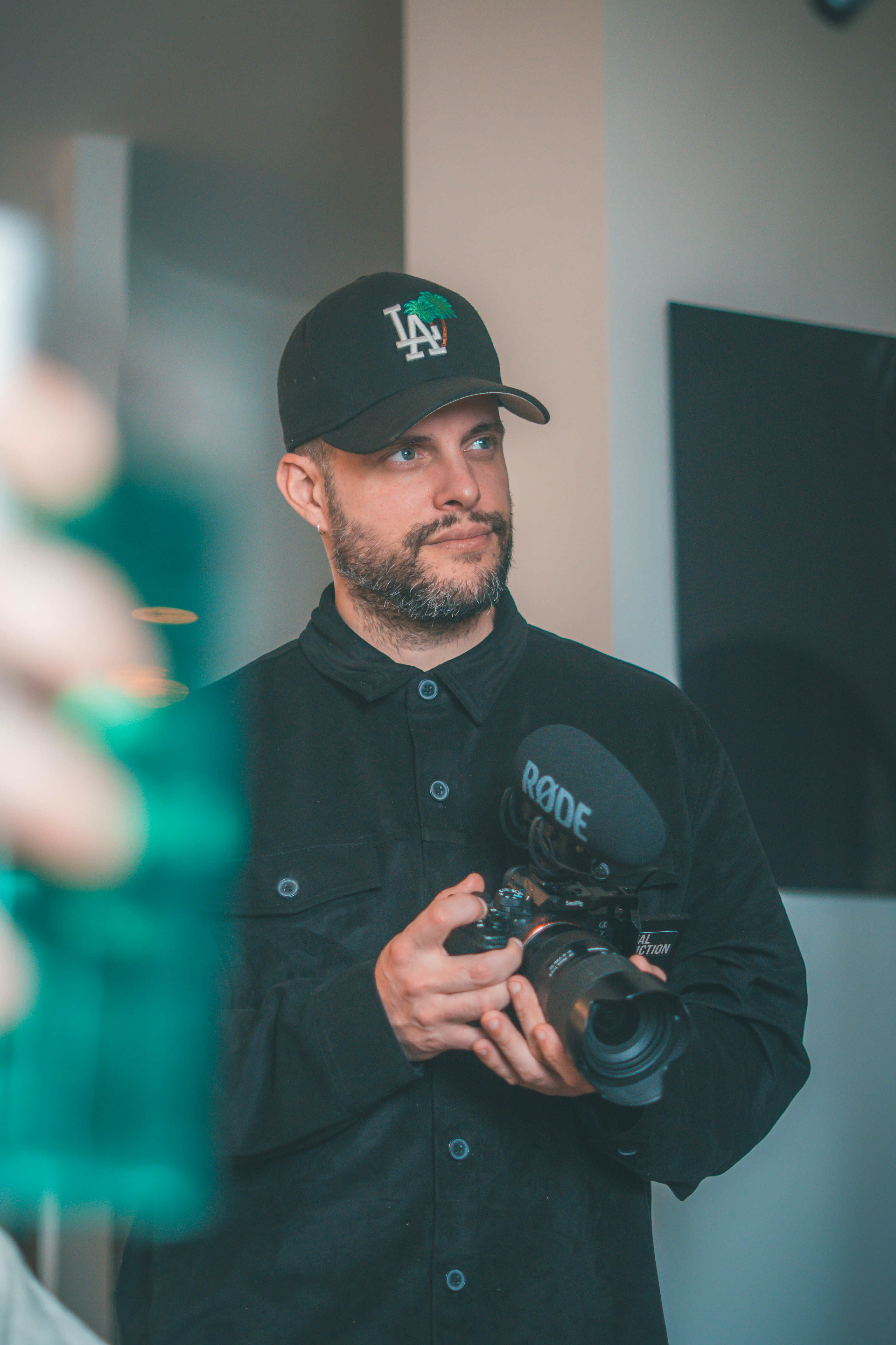 Muted Spotlight on the Interviewer: A Candid Moment with a Filmmaker's Grip