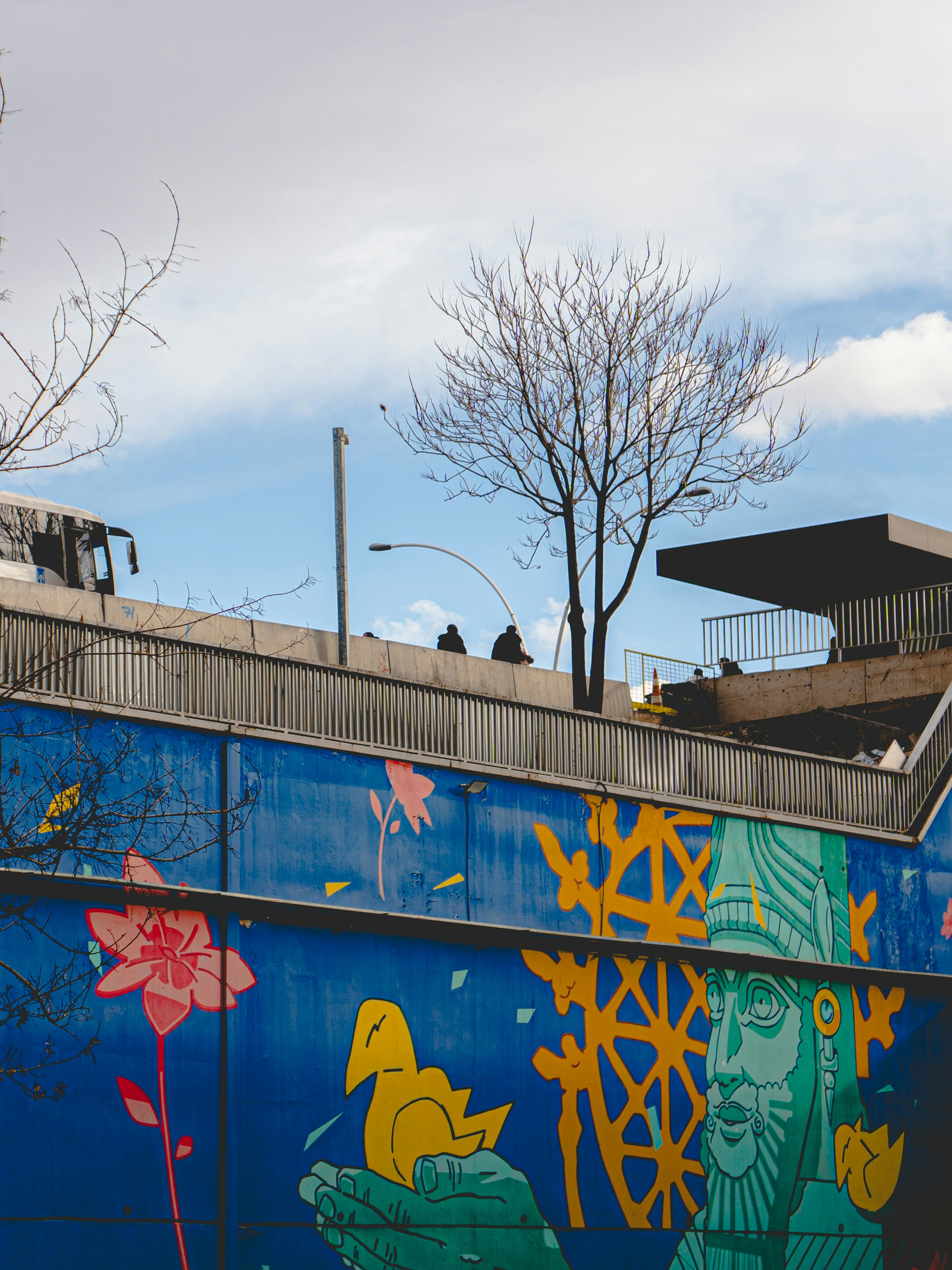 Rooftop Silhouette Over a Colorful Mural