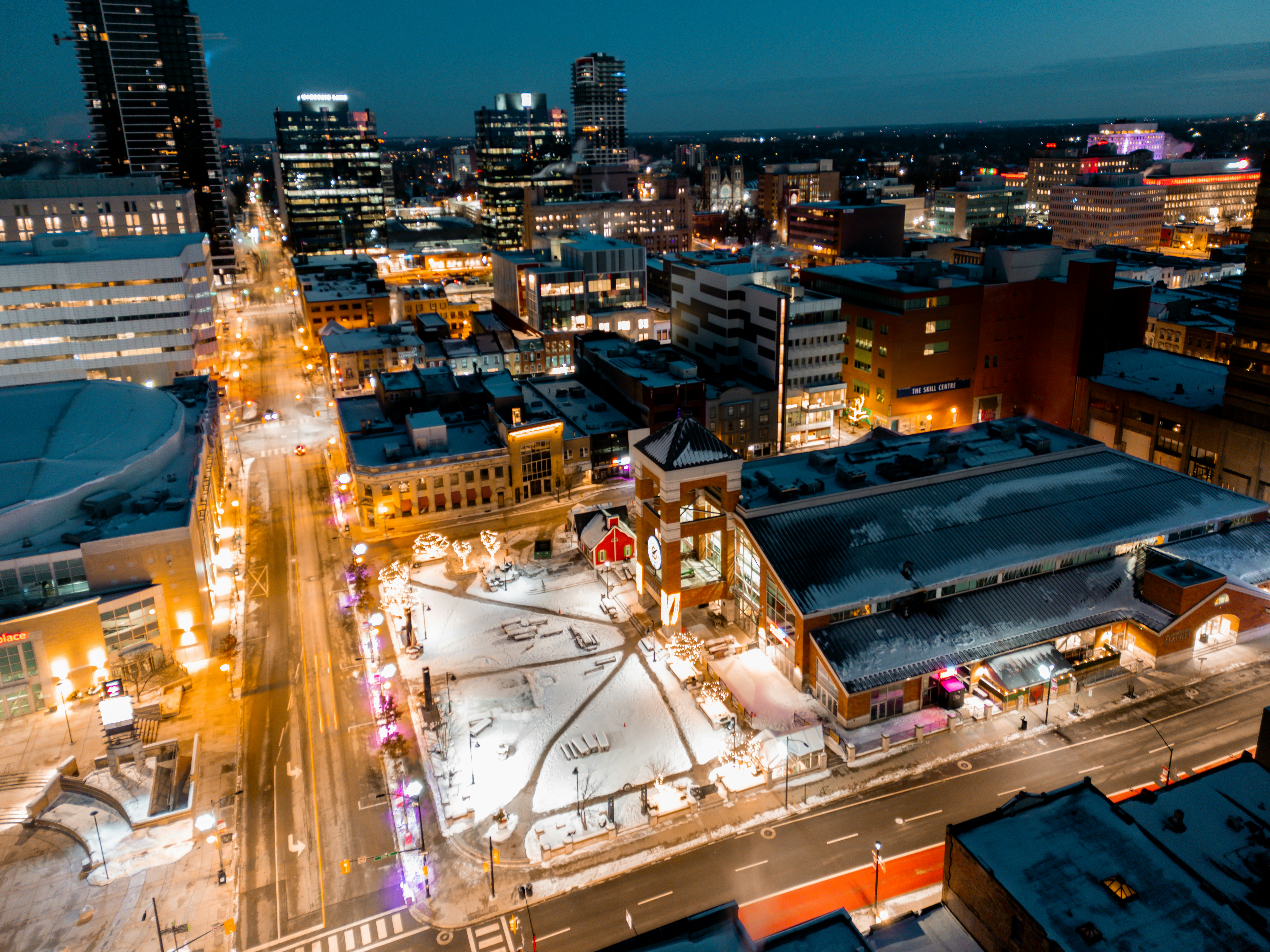 Snowy City Glow: Aerial Nightscape Over Cozy Downtown