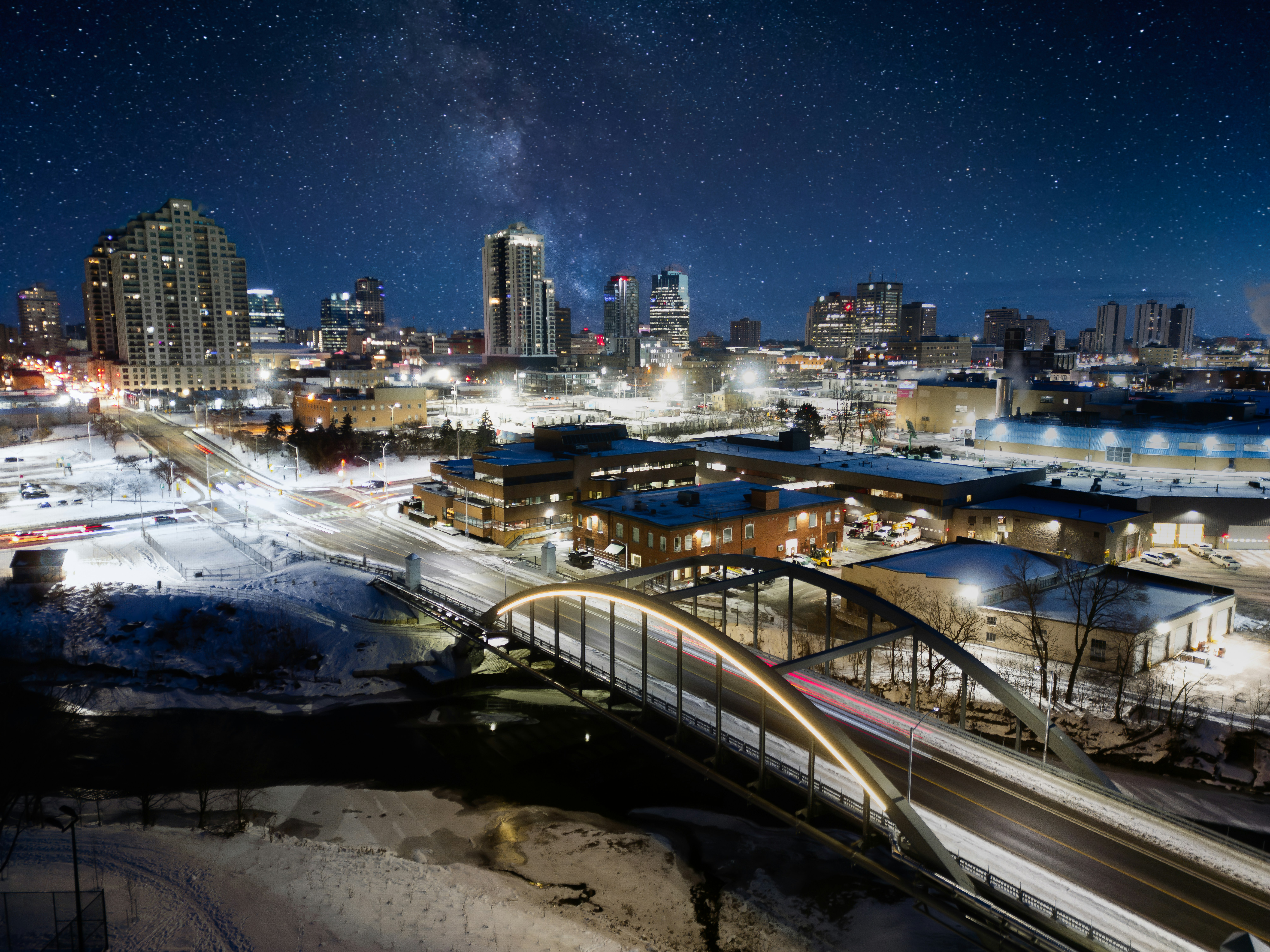 Nightscape Over the Snowy Bridge to a Cozy Urban Waterfront