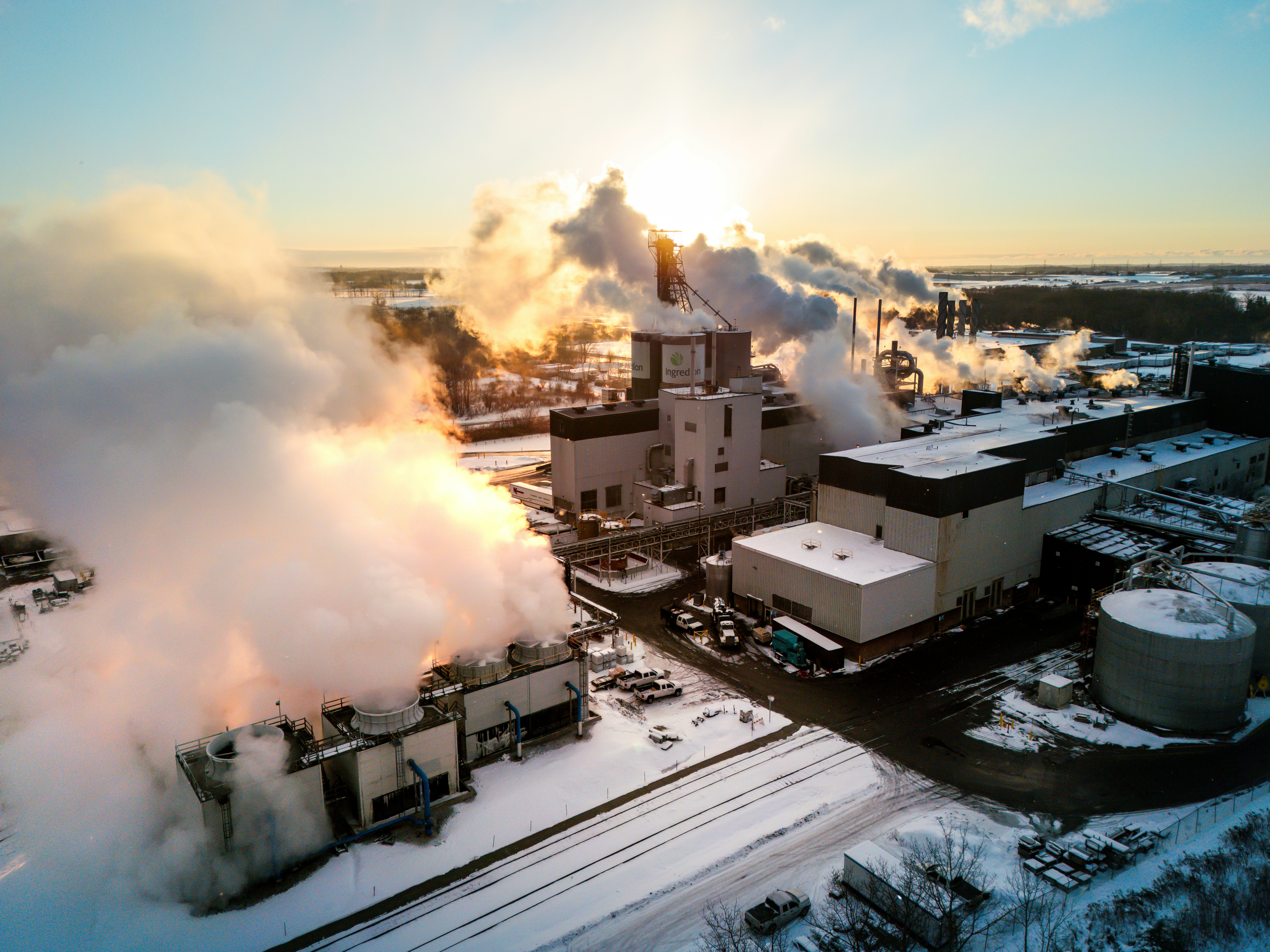 Industrial Steam: Sunrise Over a Snow-Cooled Factory