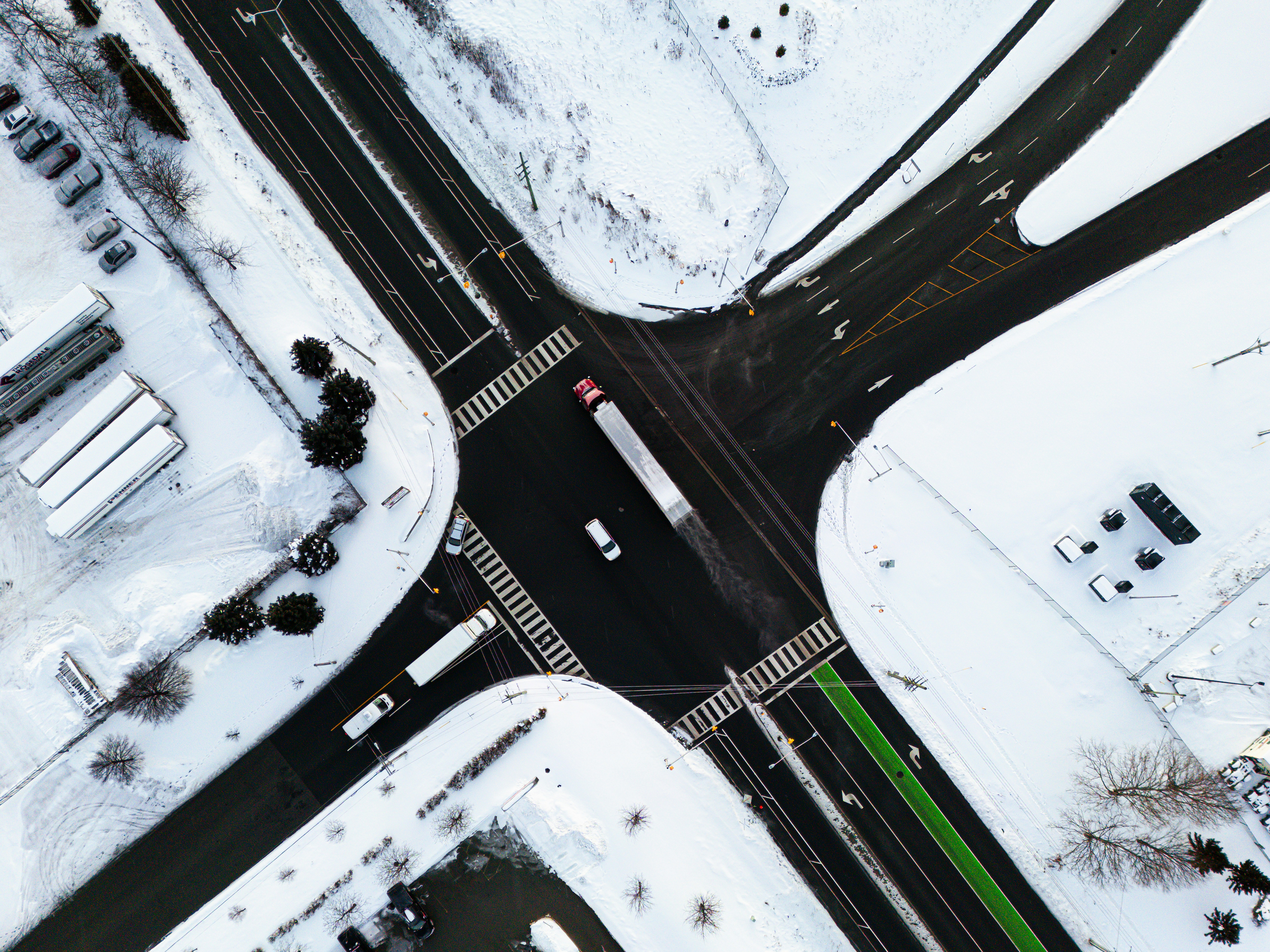 Snowbound Crossroads: Aerial View of a Tidy Urban Junction in Winter