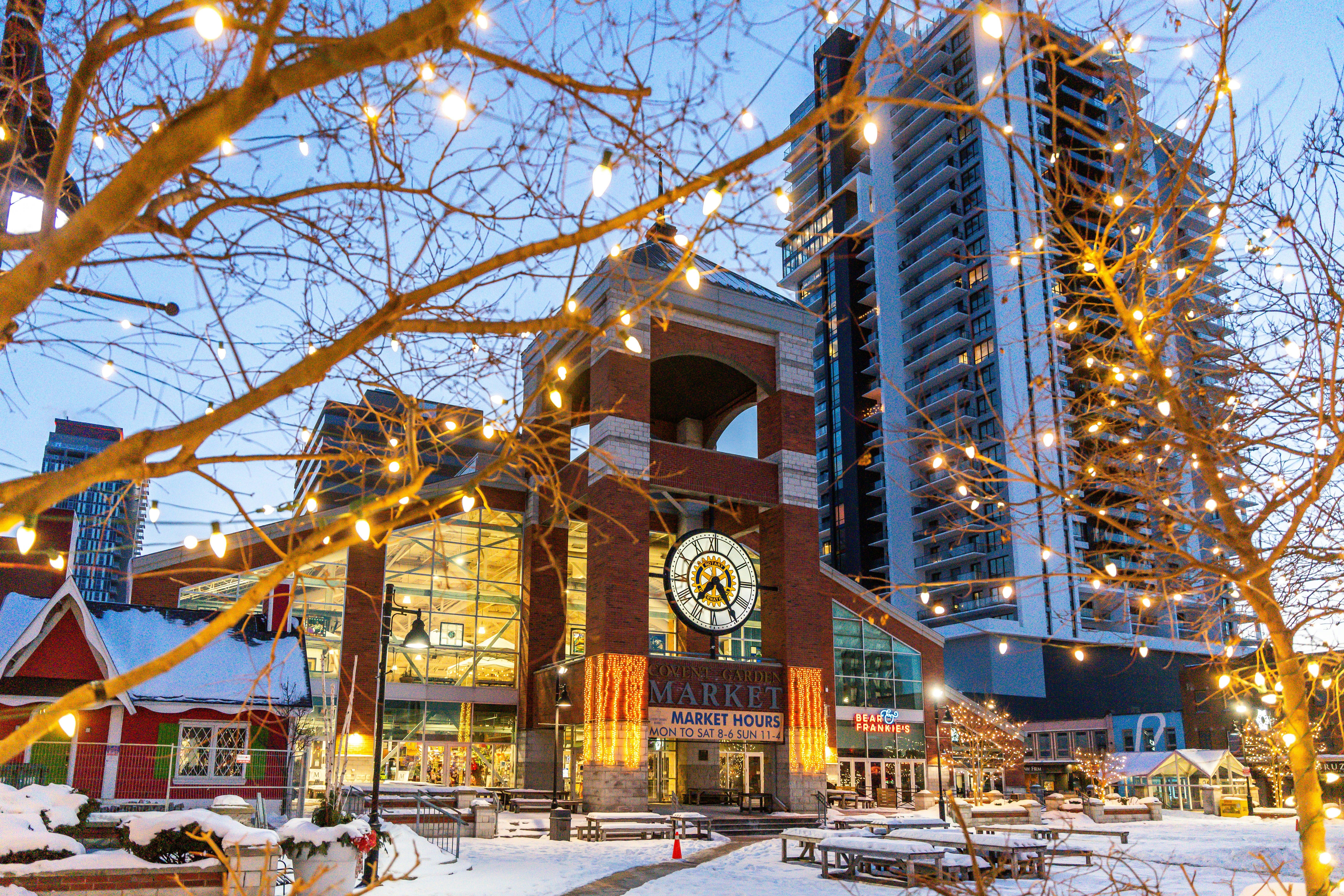 Twinkling Market Lights Over Snow-Hushed Urban Market