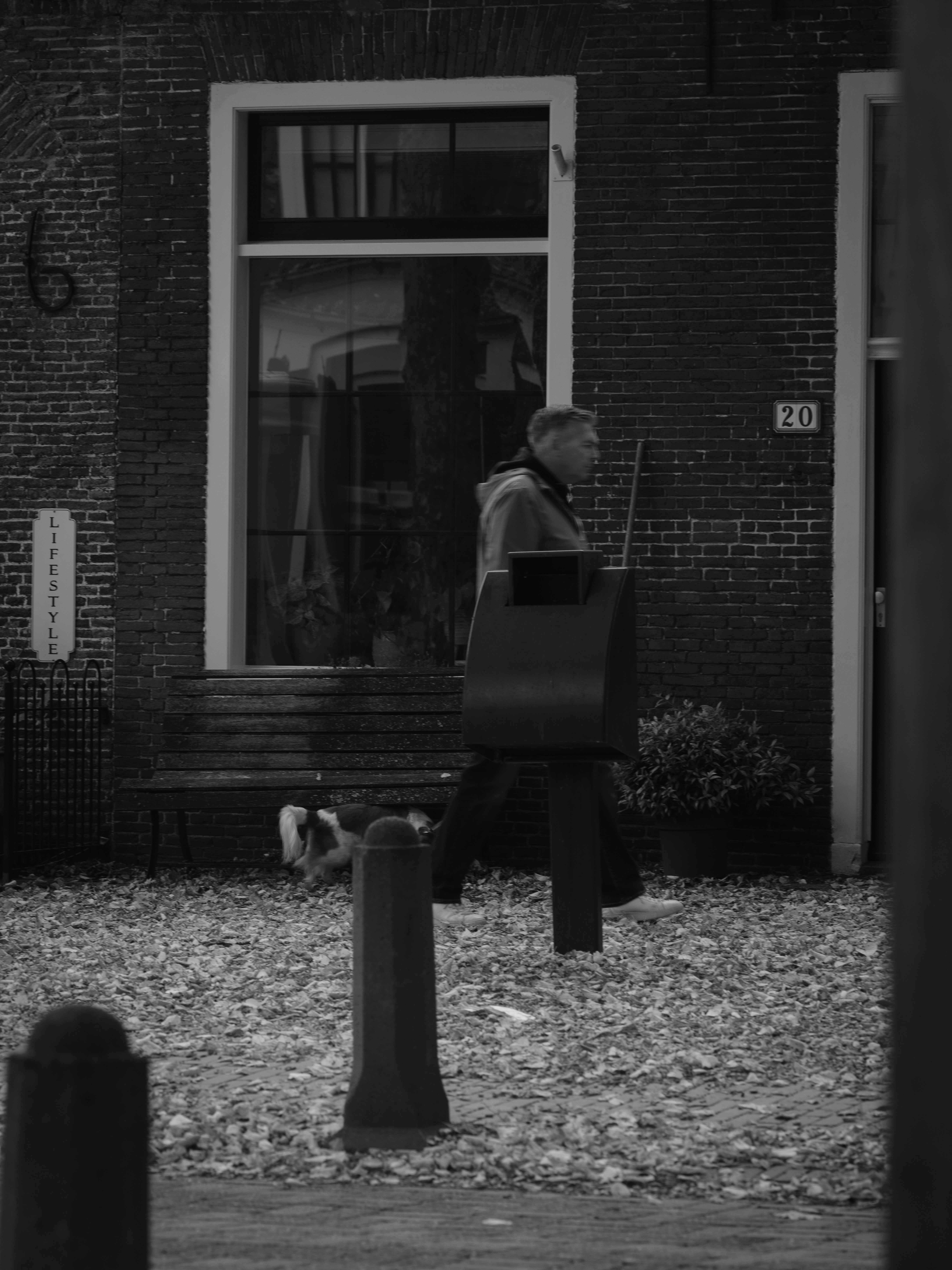 A Quiet Stroll by the Brick Facade